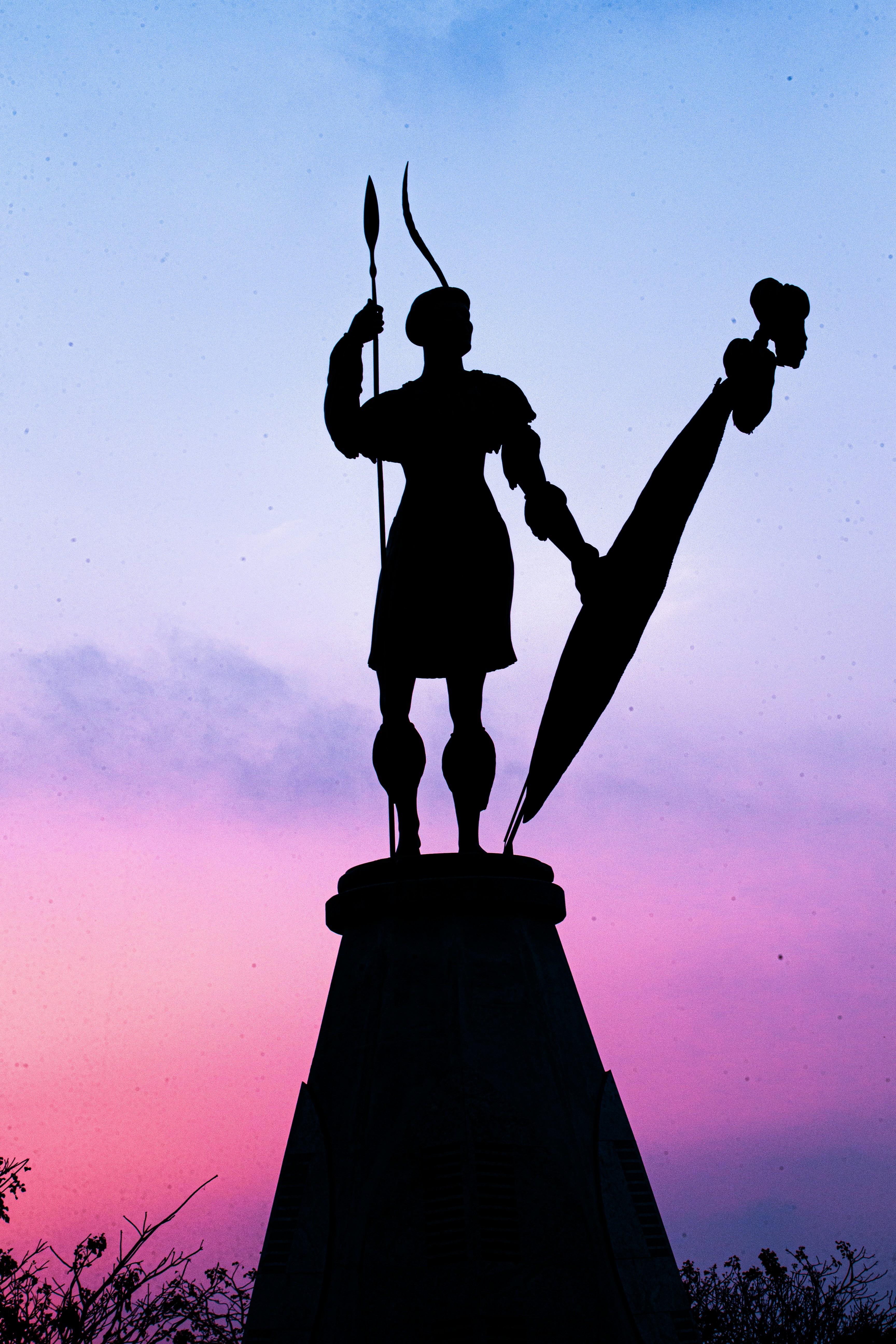 Silhouette of a Warrior atop a Monument at Sunset
