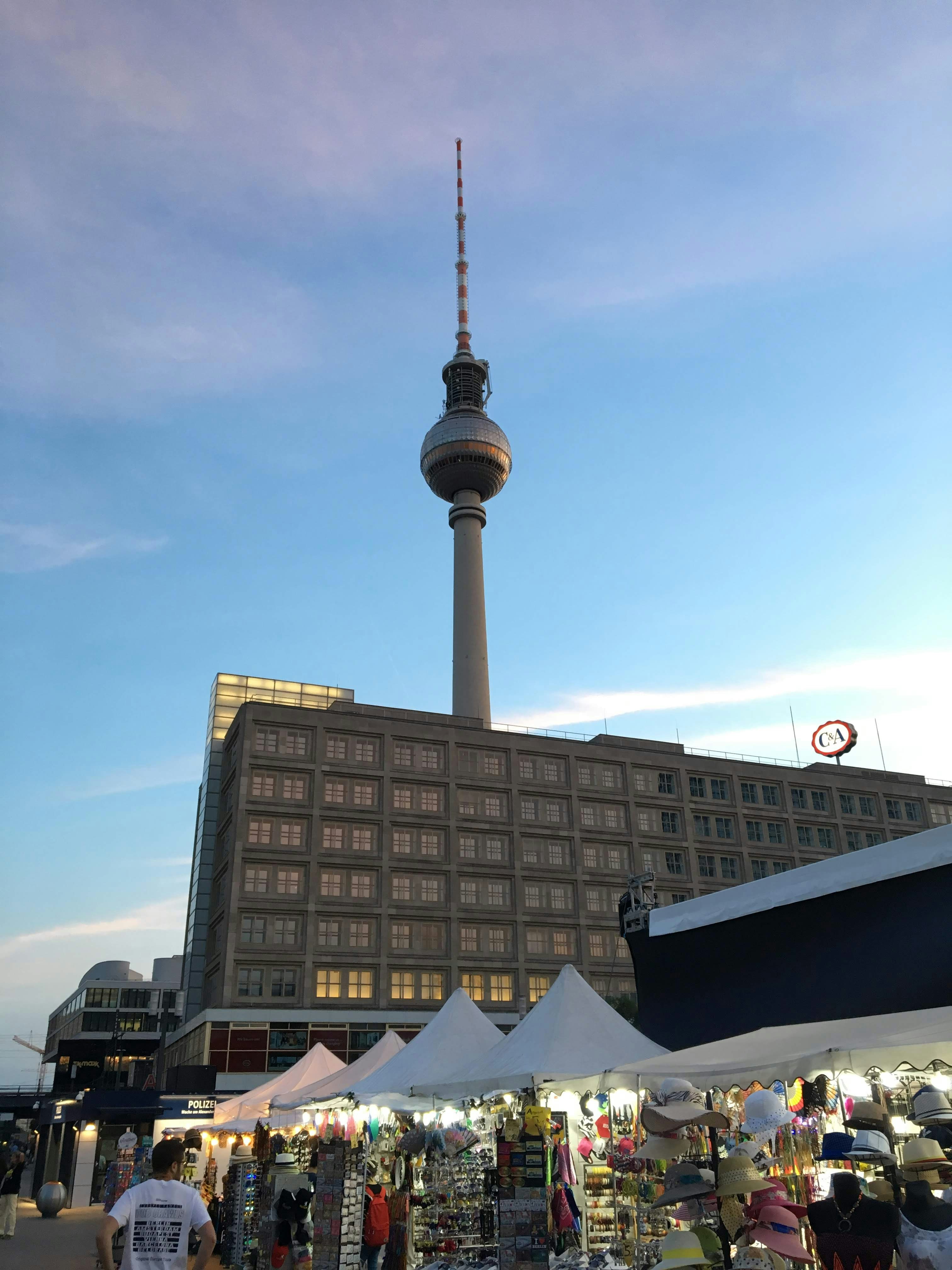 Towering Skyline Over Market Stalls at Dusk