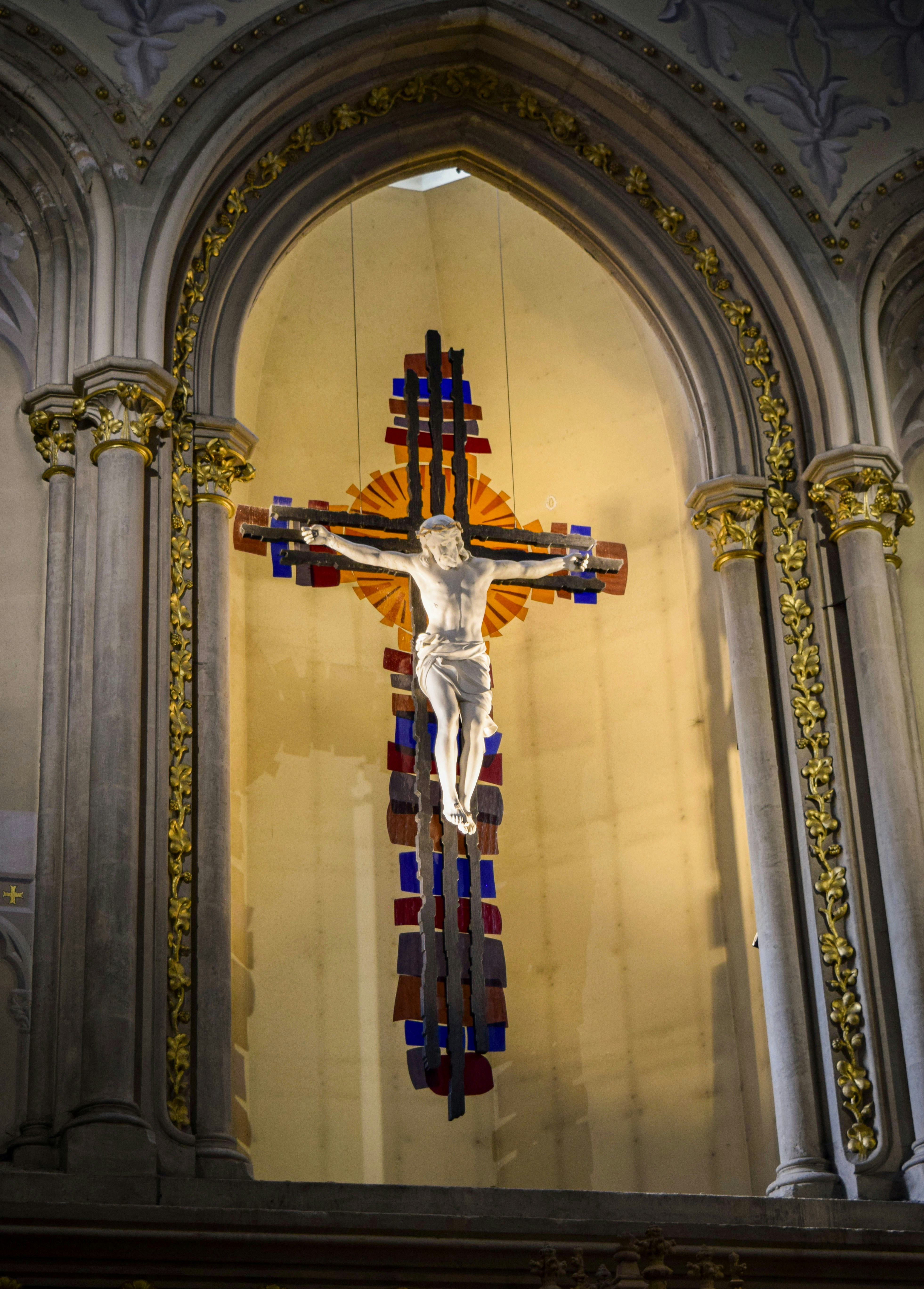 Crucifix in a gilded chapel: color-splashed centerpiece under vaulted arches