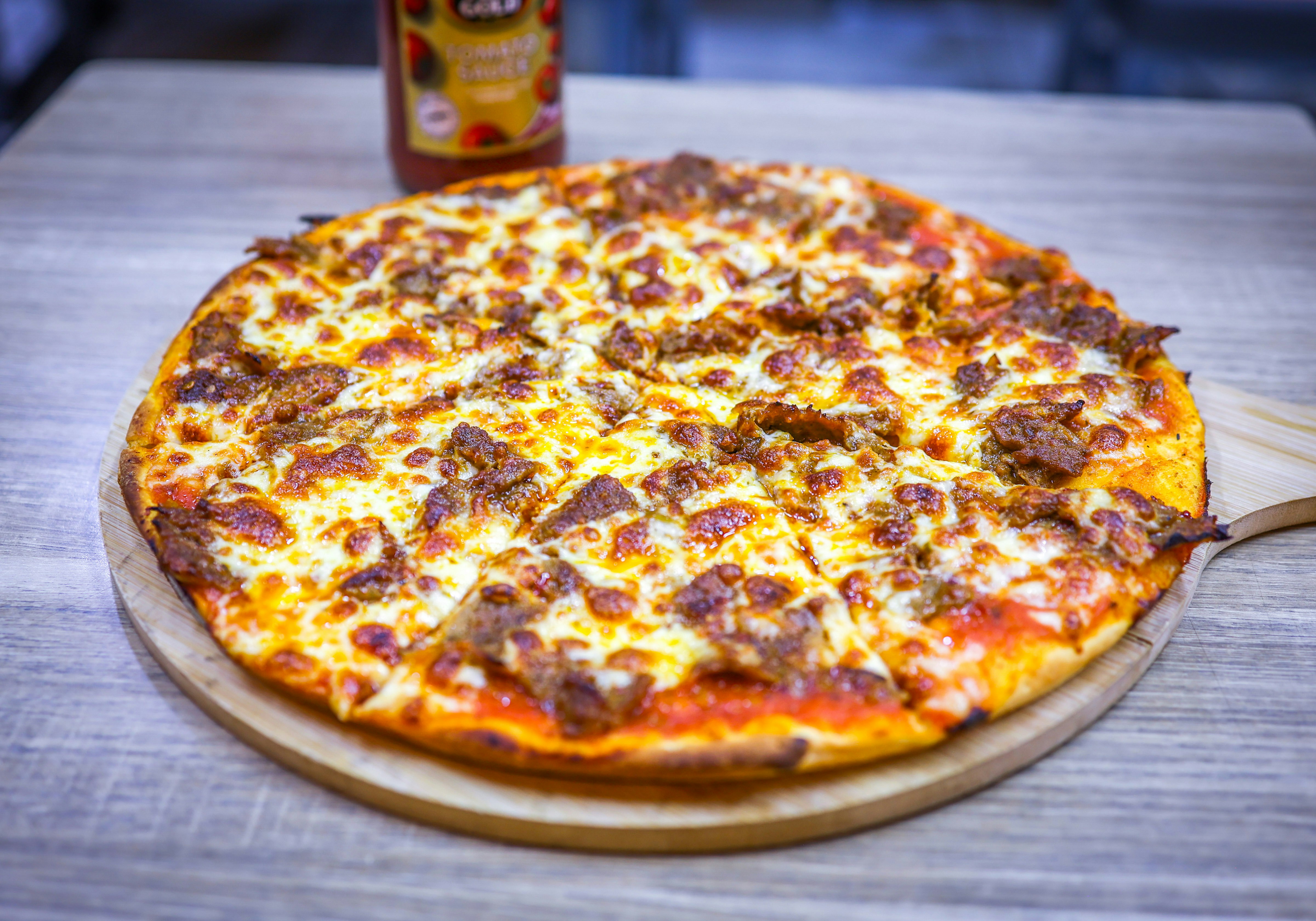 Charred cheese and pepperoni crown on a rustic wooden board