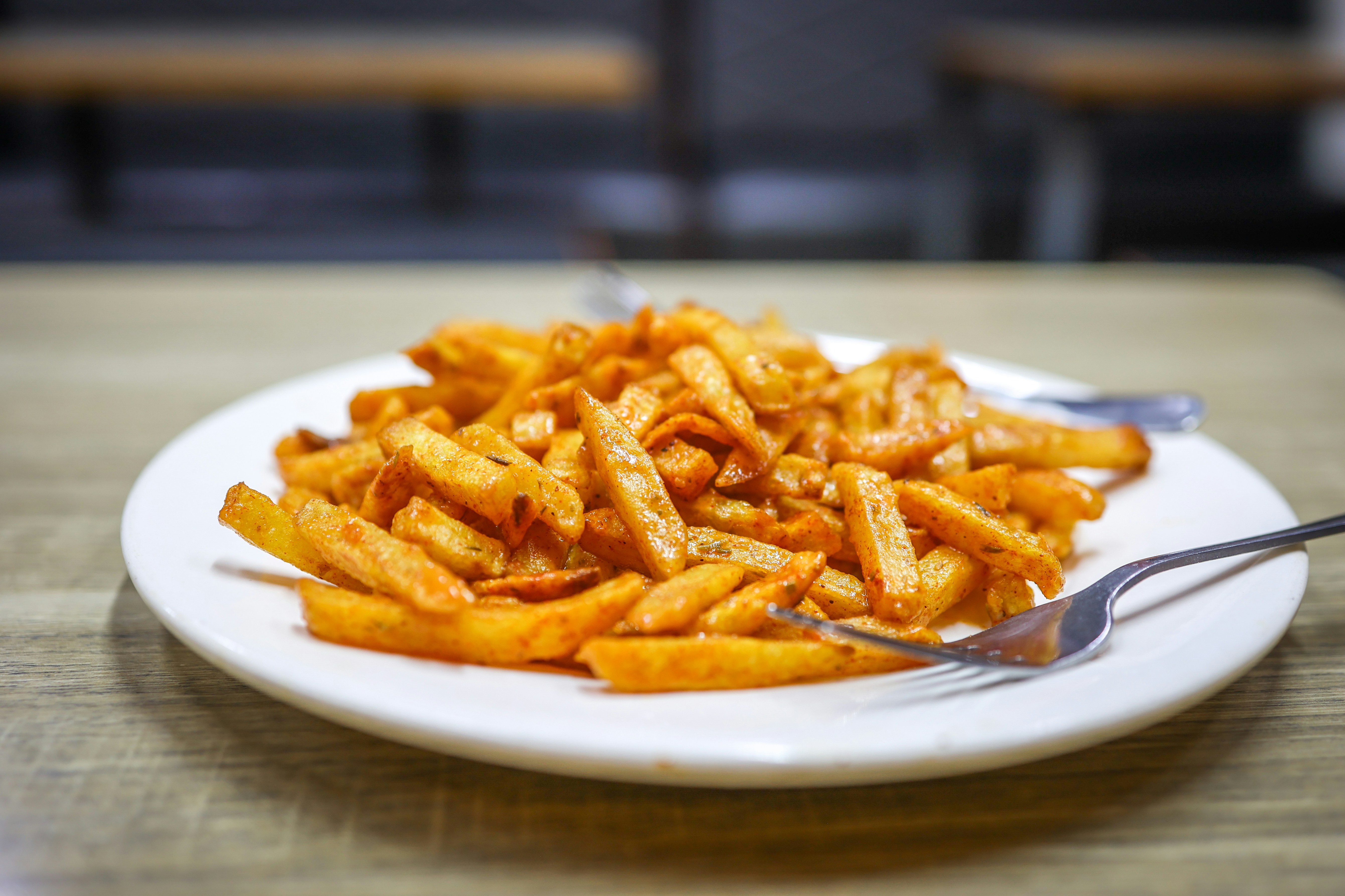 Crisped Gold: A Plate of Fragrant Fries on a Rustic Table