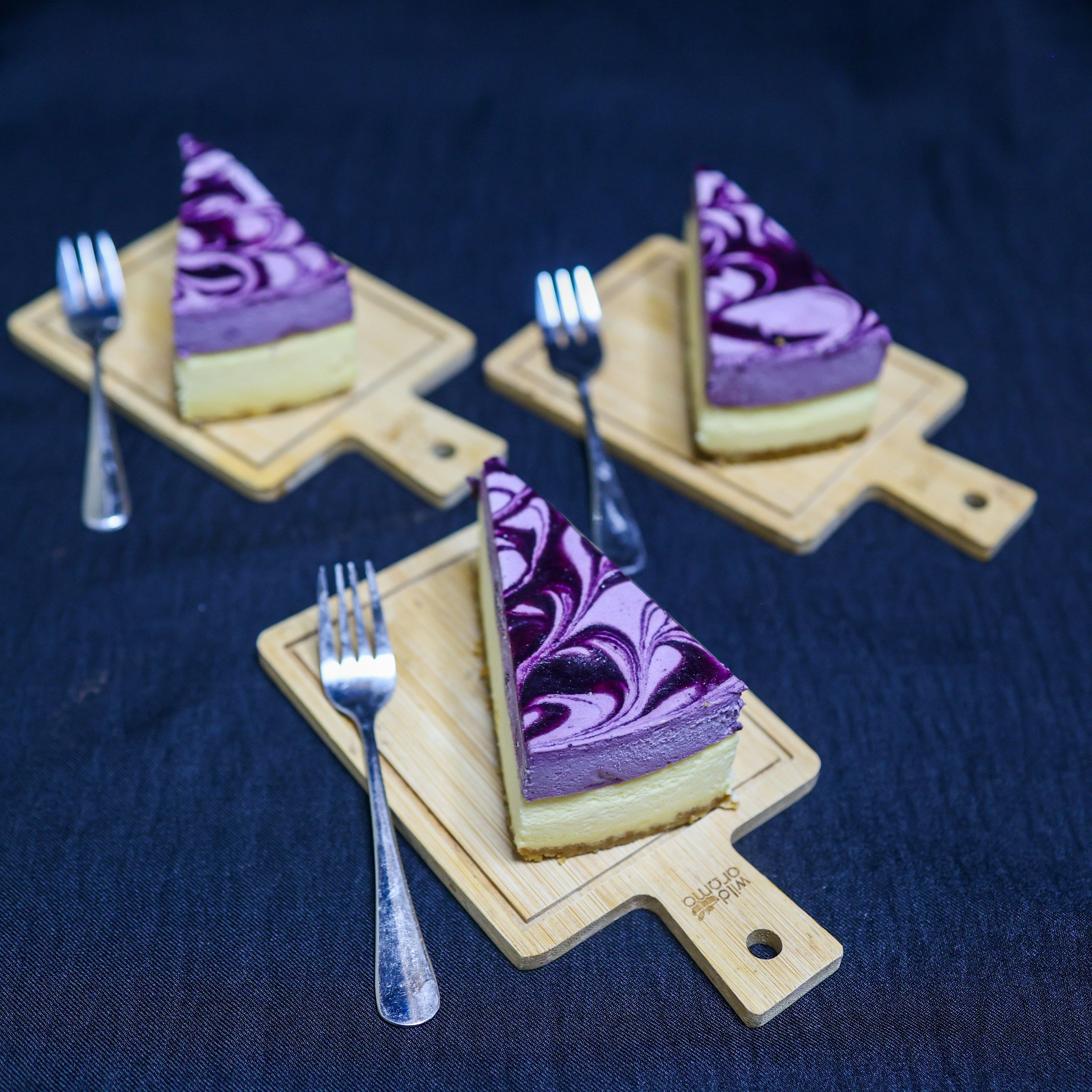 Violet Swirl Cheesecake Trio on Wooden Boards
