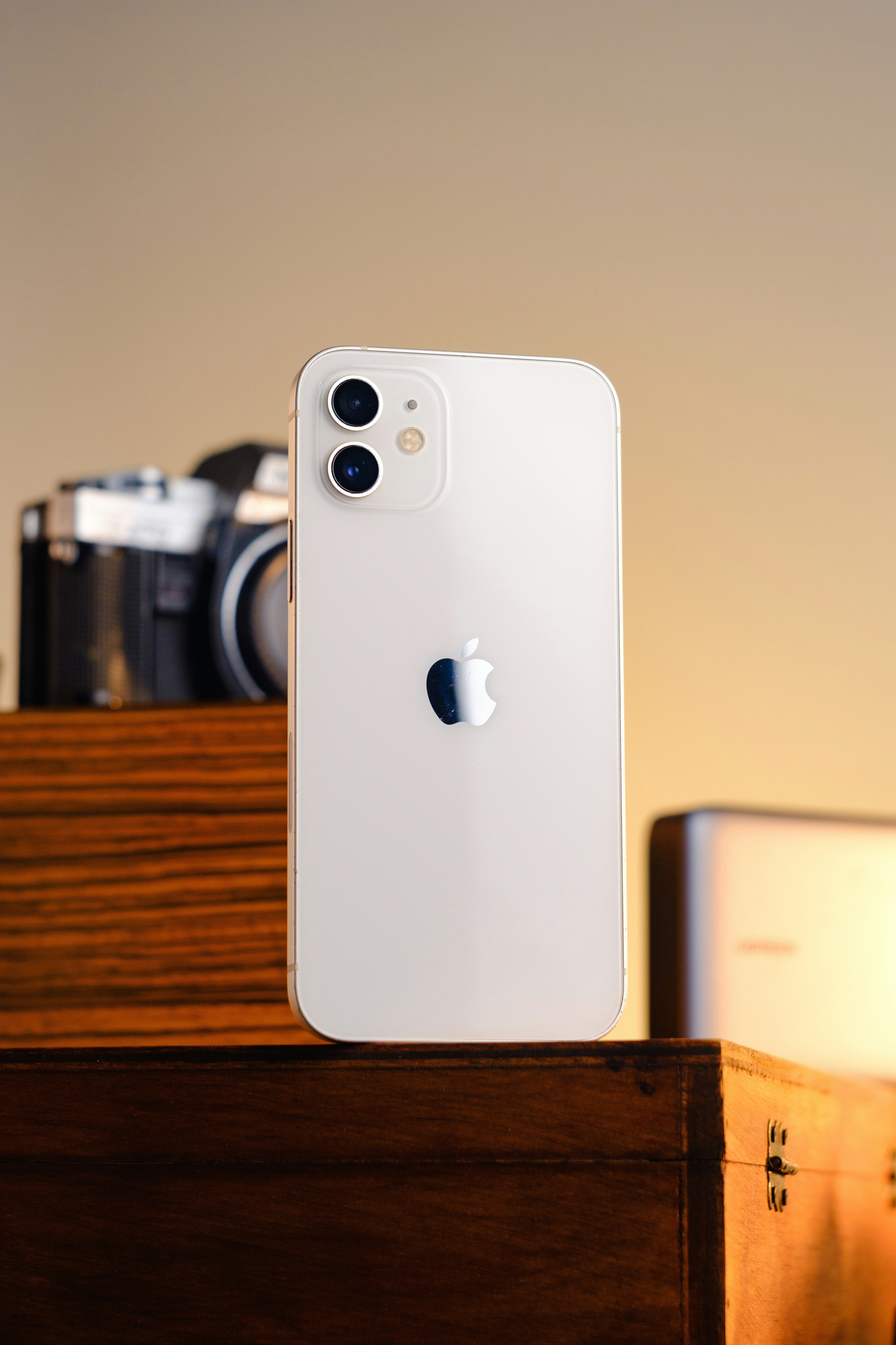 Portrait of a Glassy Moment: A Silver iPhone Stands Quietly On Wood