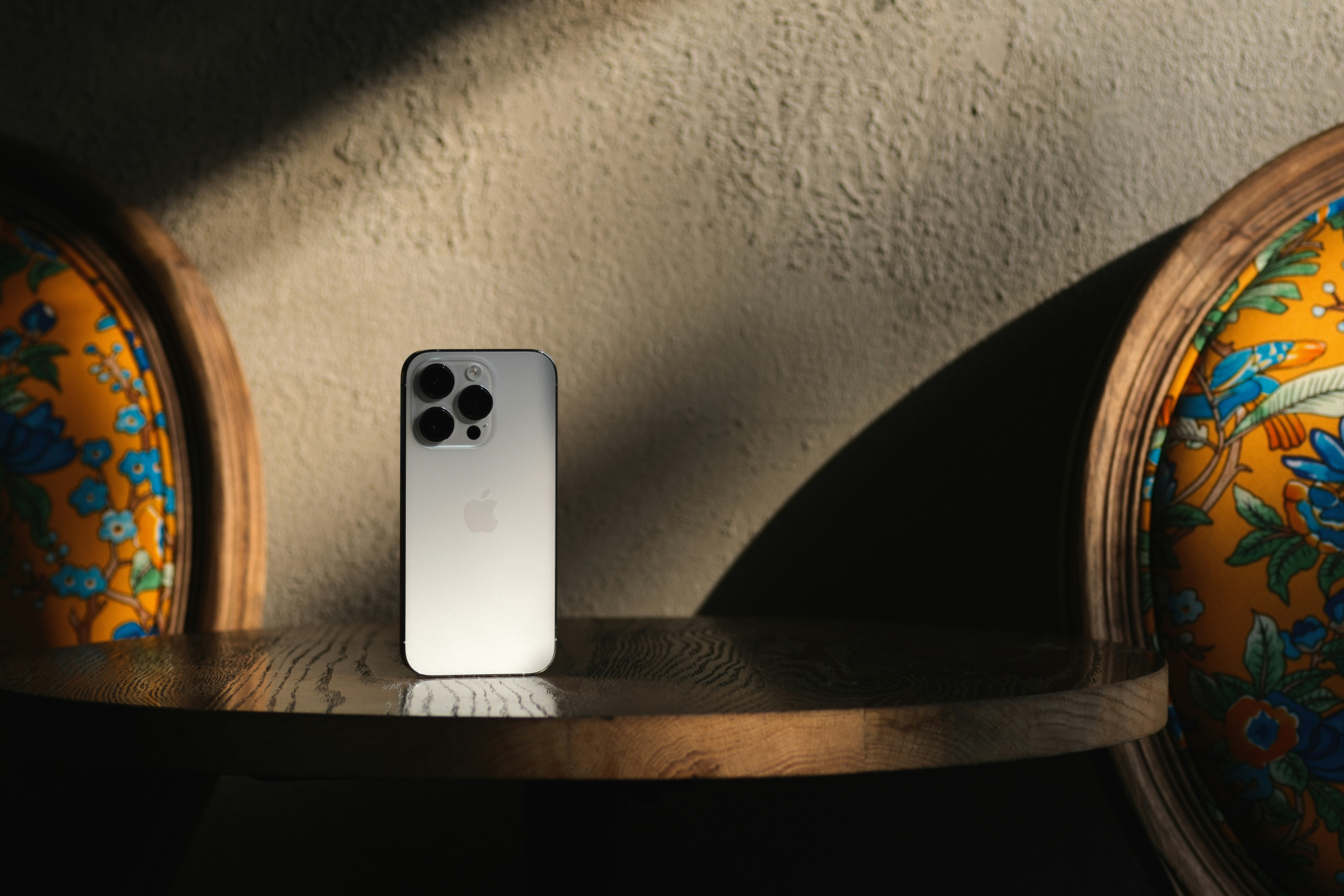 Midnight Spotlight: A Silver iPhone Reigns on a Quiet Table