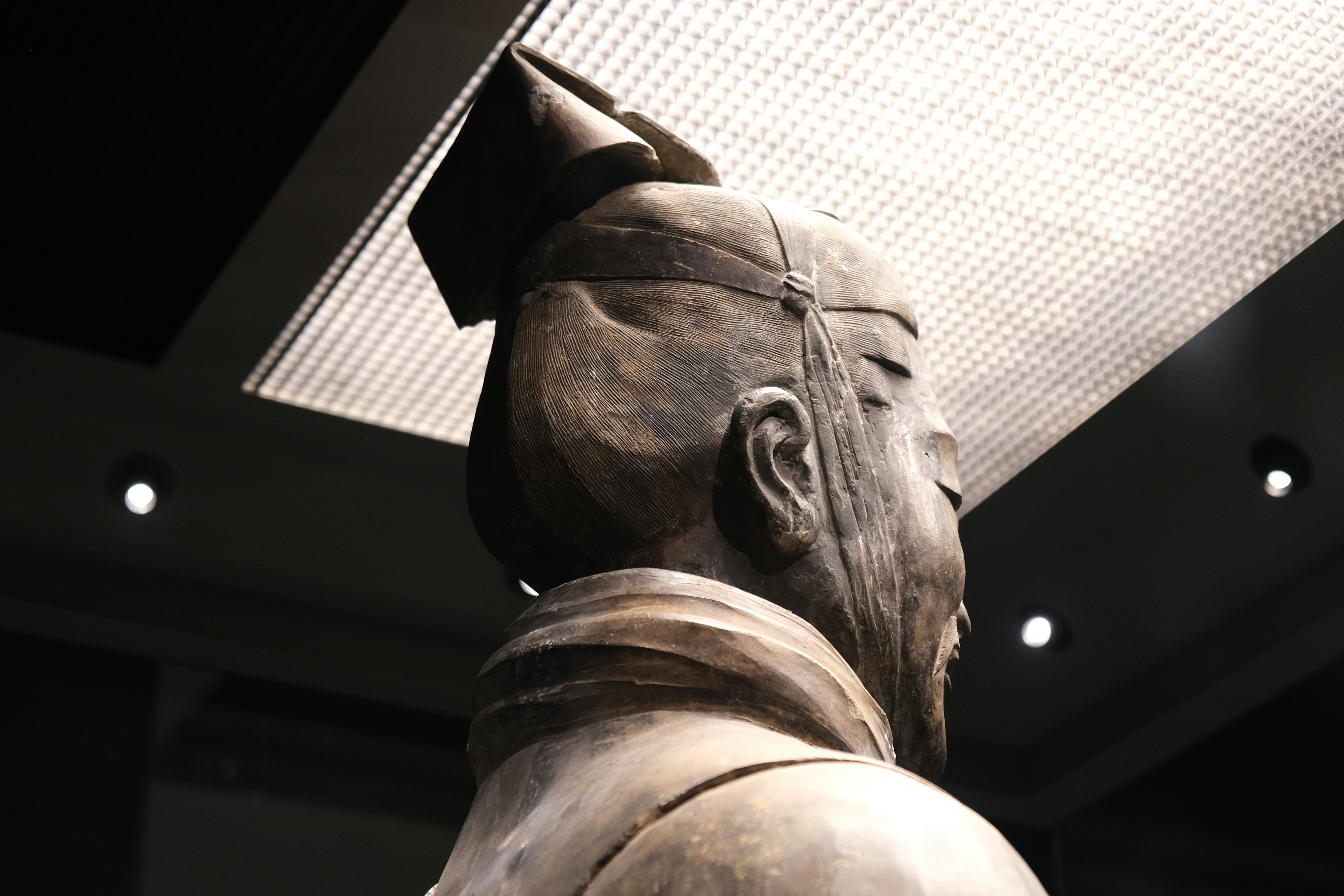 Silent Scholar: A Bronze Head Under Modern Lights