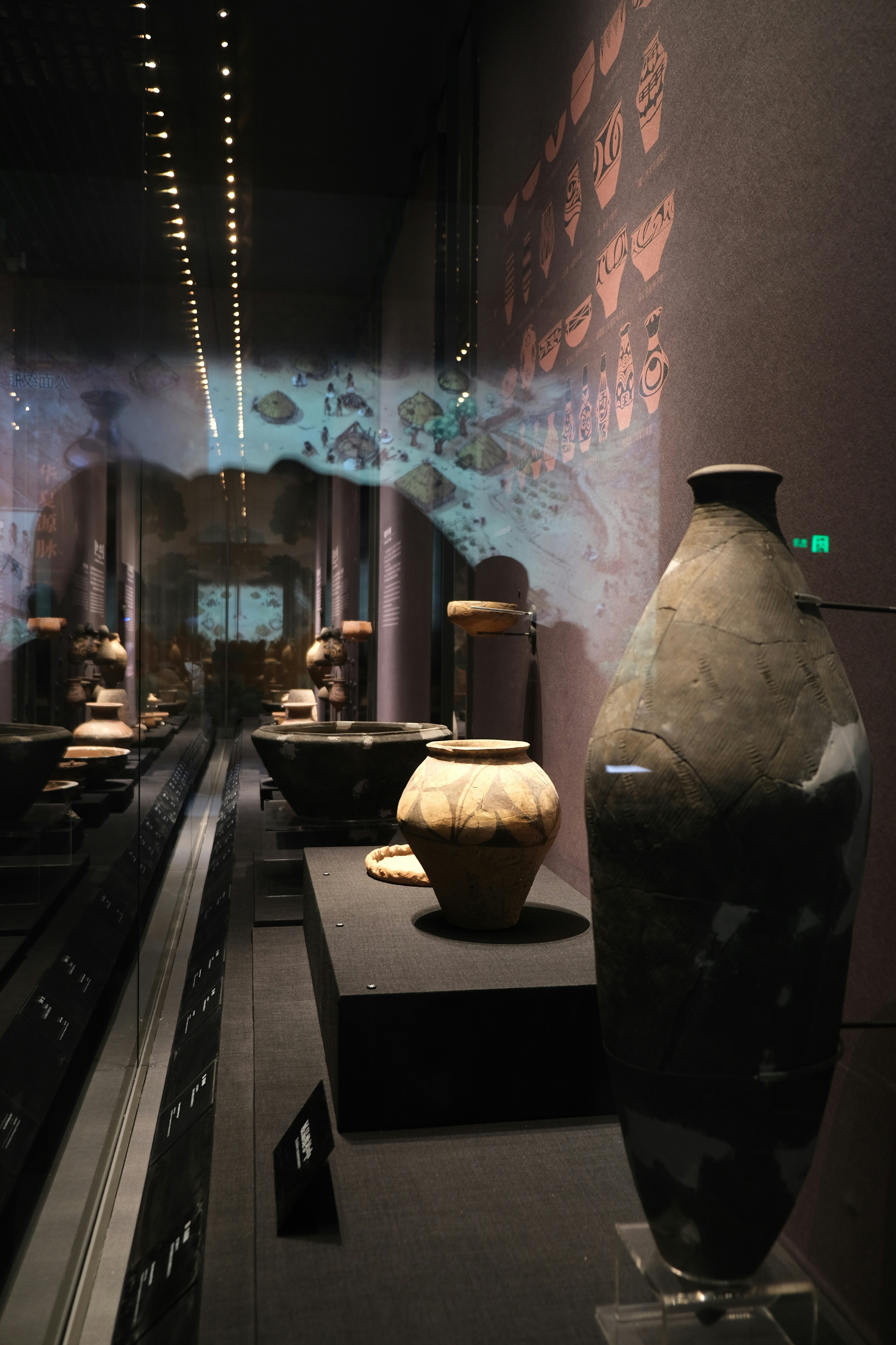 Vessel Gallery: Ceramics and Reflections in a Dim Exhibition Hall