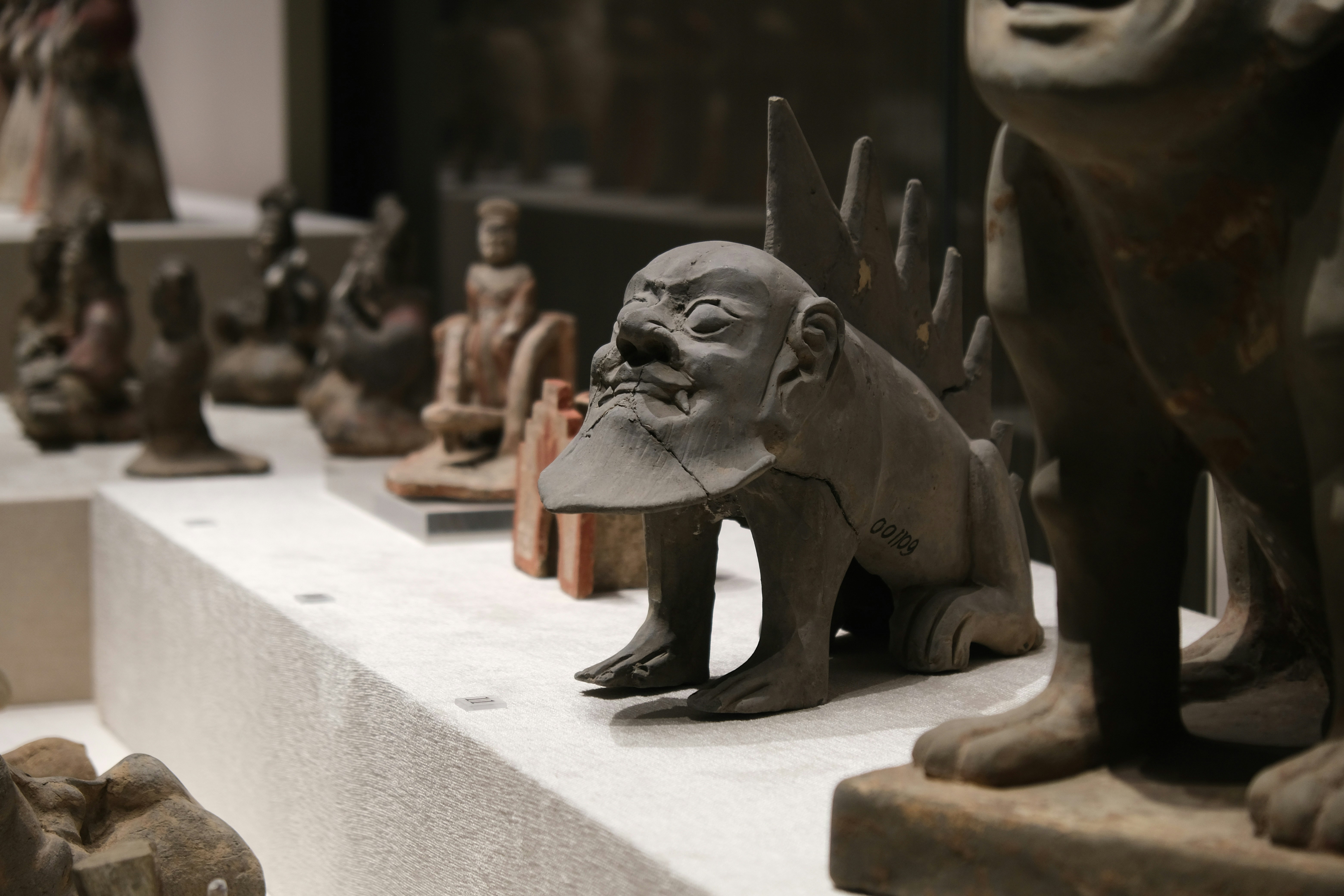 Grinning Gargoyle Among Tiny Tomes: A Studio Shelf of Figurative Clay