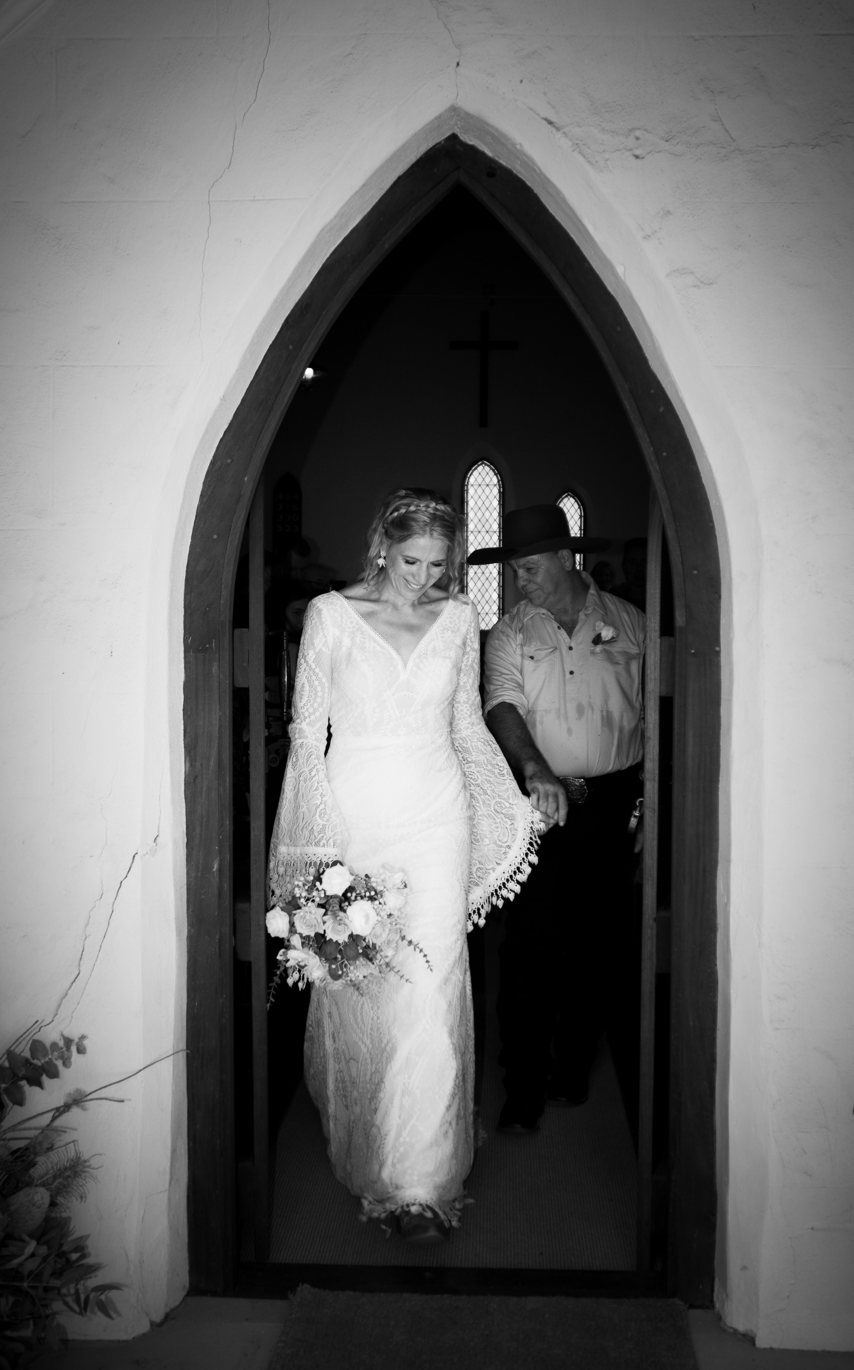 Bride in Lace Walk: Quiet Moment at the Chapel Threshold