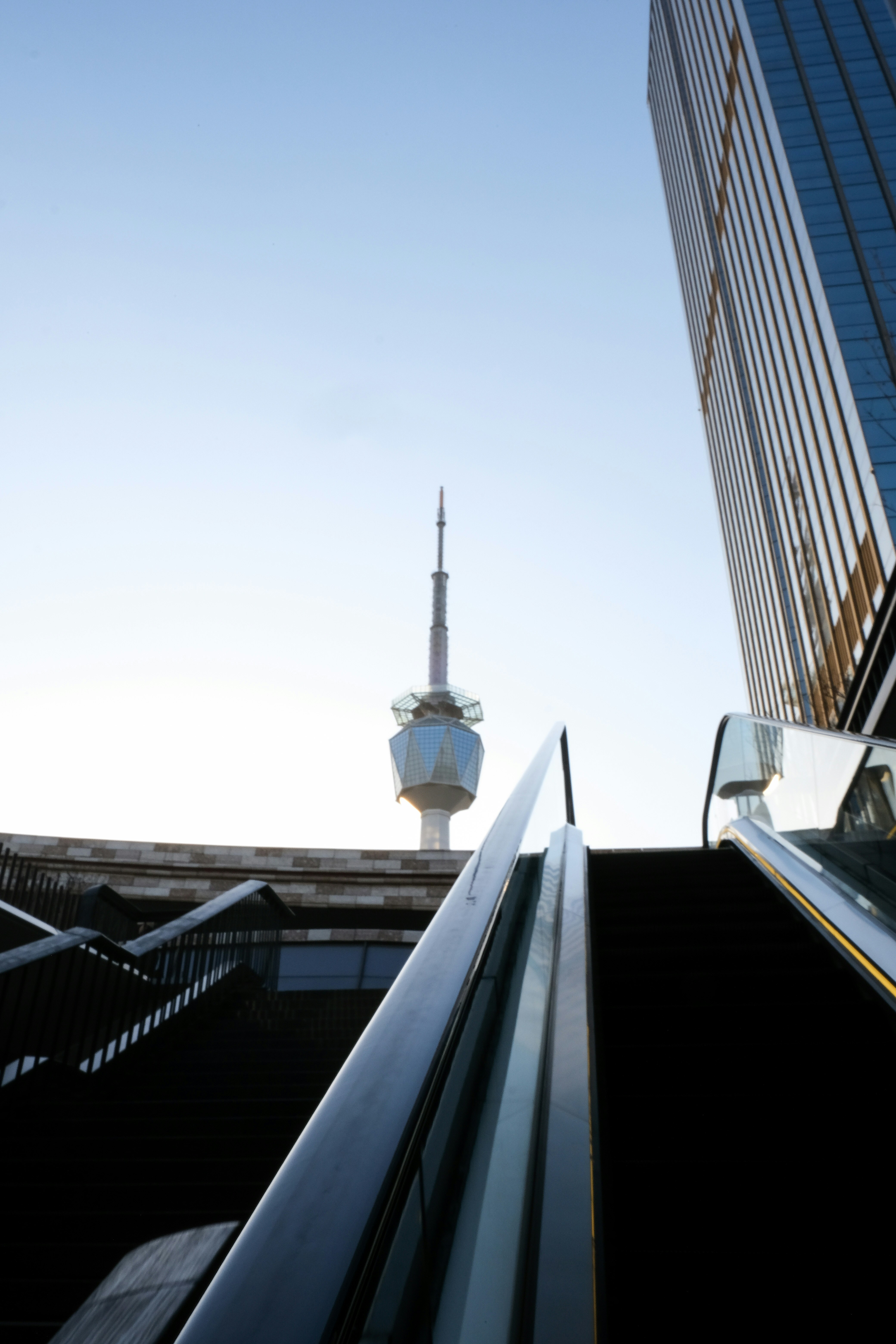 Escalator Toward the Sky: A City Tower in Focus
