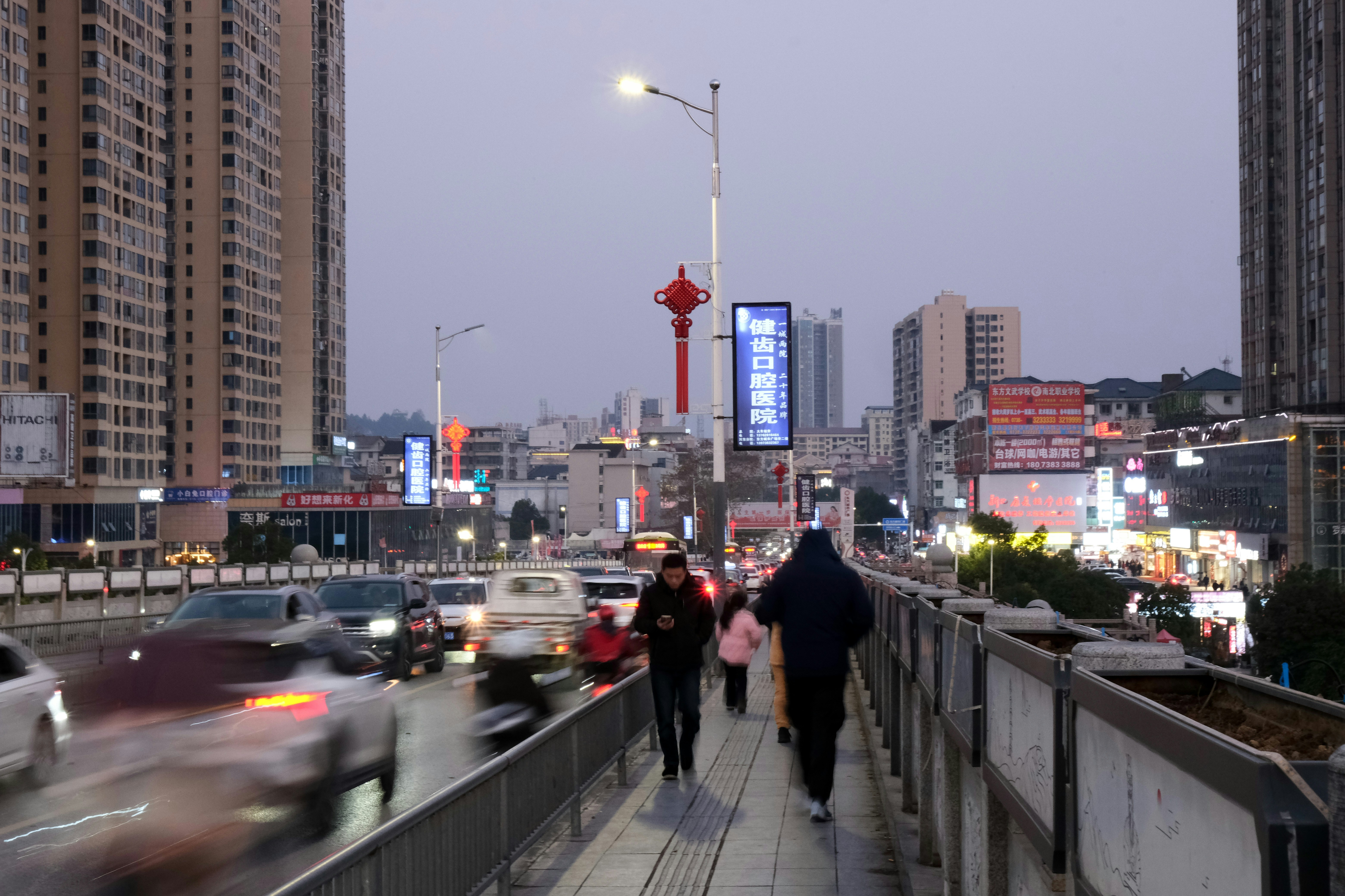Urban Pedestrian Bridge in Motion Under Neon Skyline