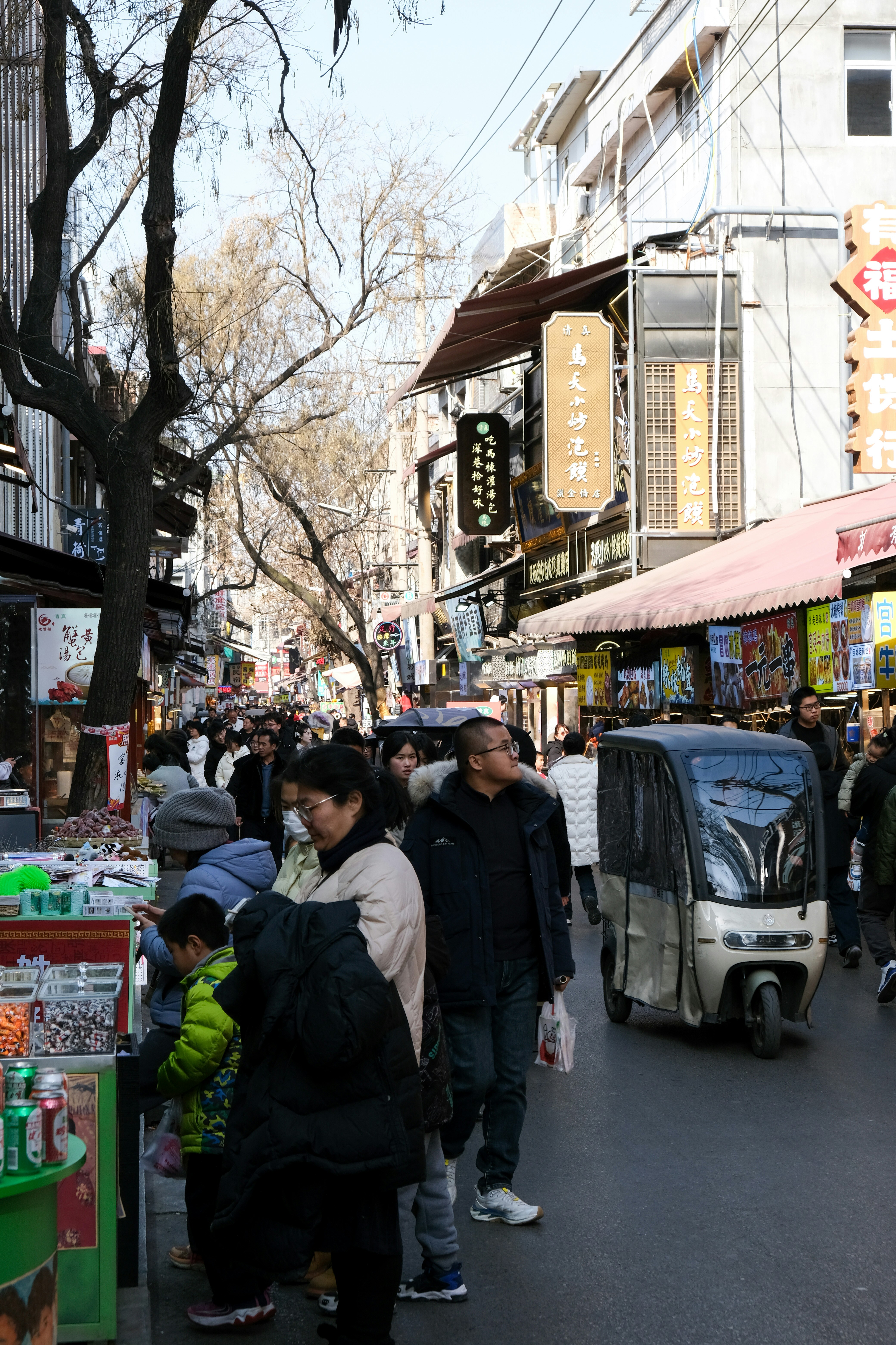 Crowded Shouts and Shopfront Echoes on a Busy Street