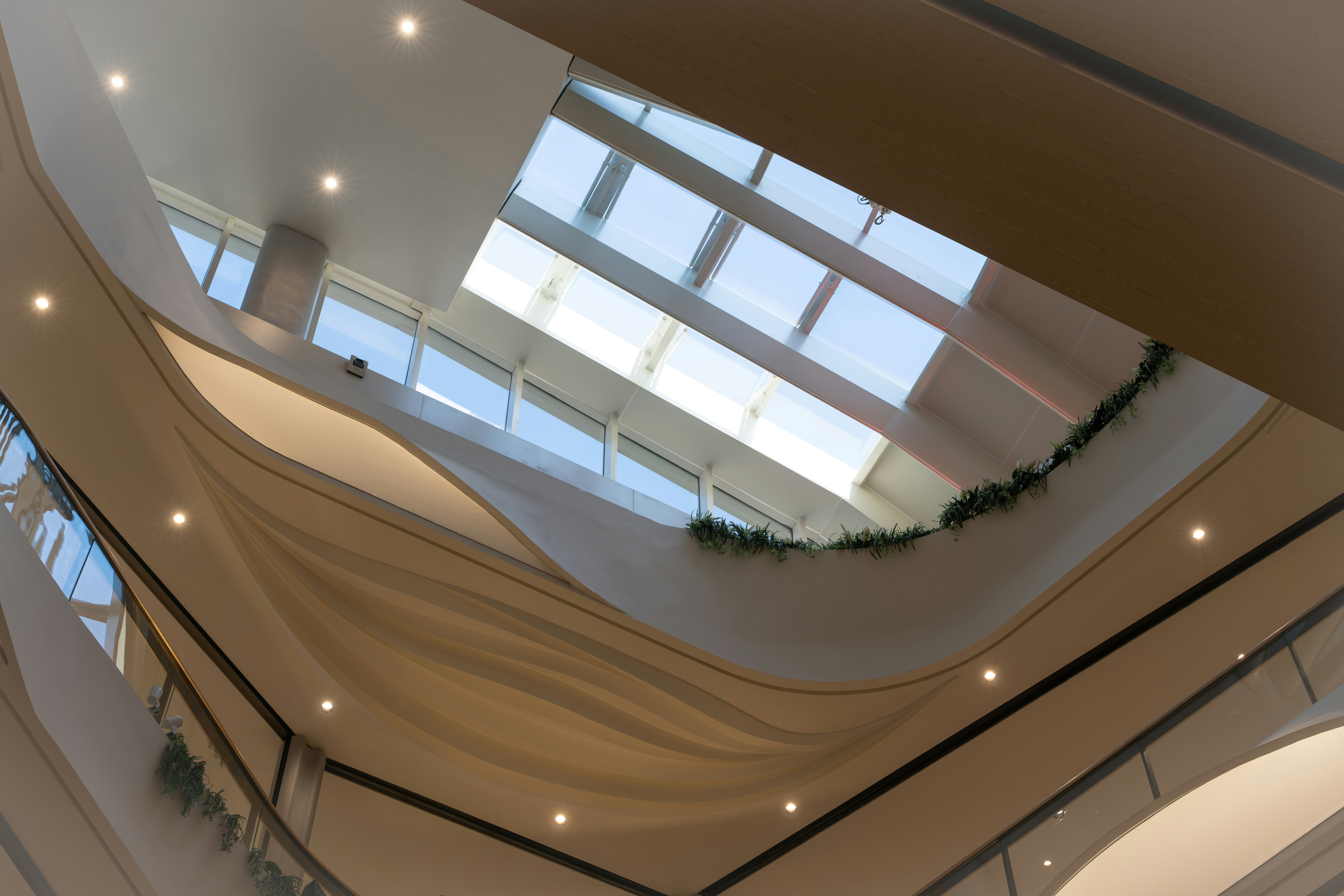 Curved Atrium Whispers: A Spiral of Light