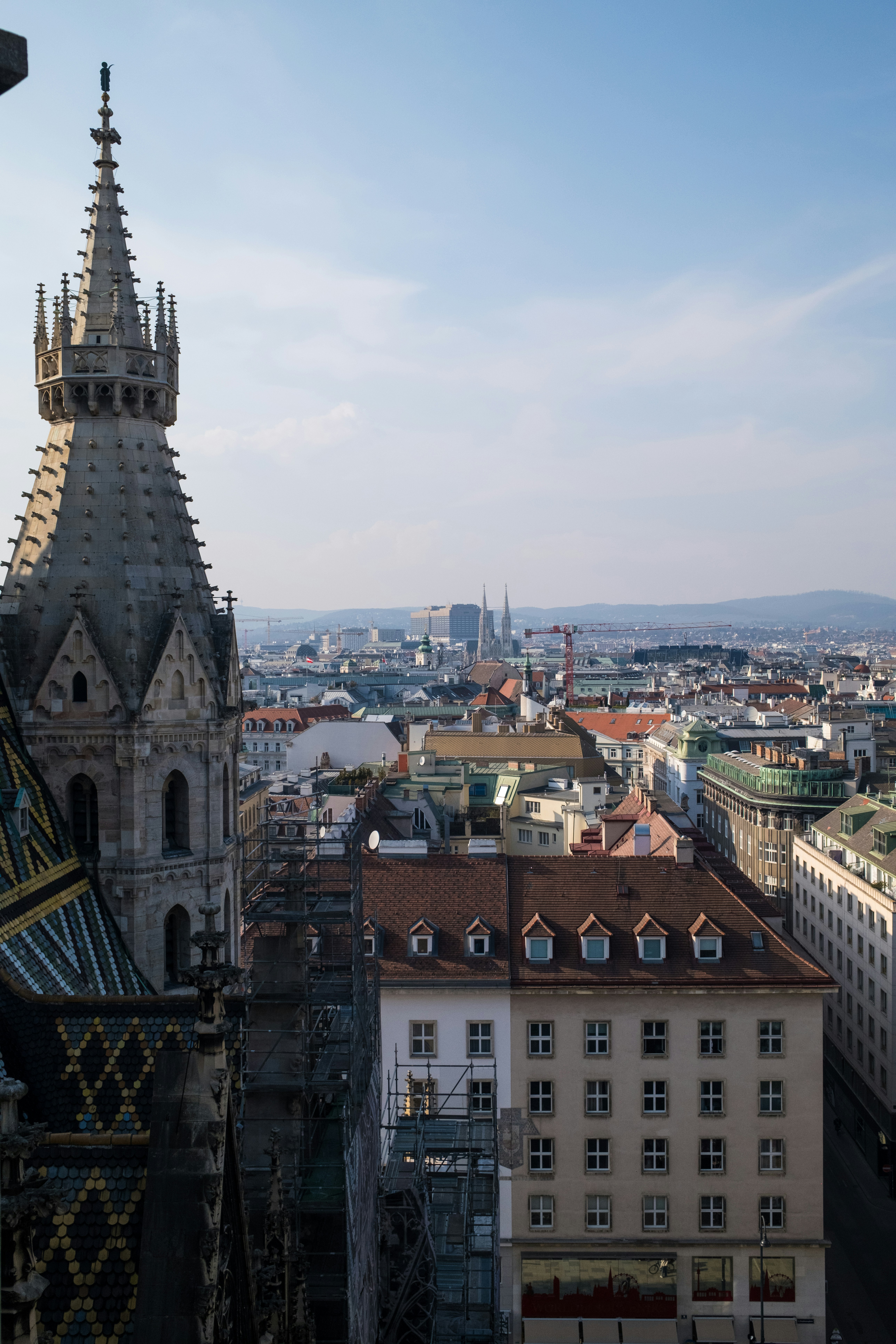 Gothic Spire Over Prague-Style Rooftops at Daylight