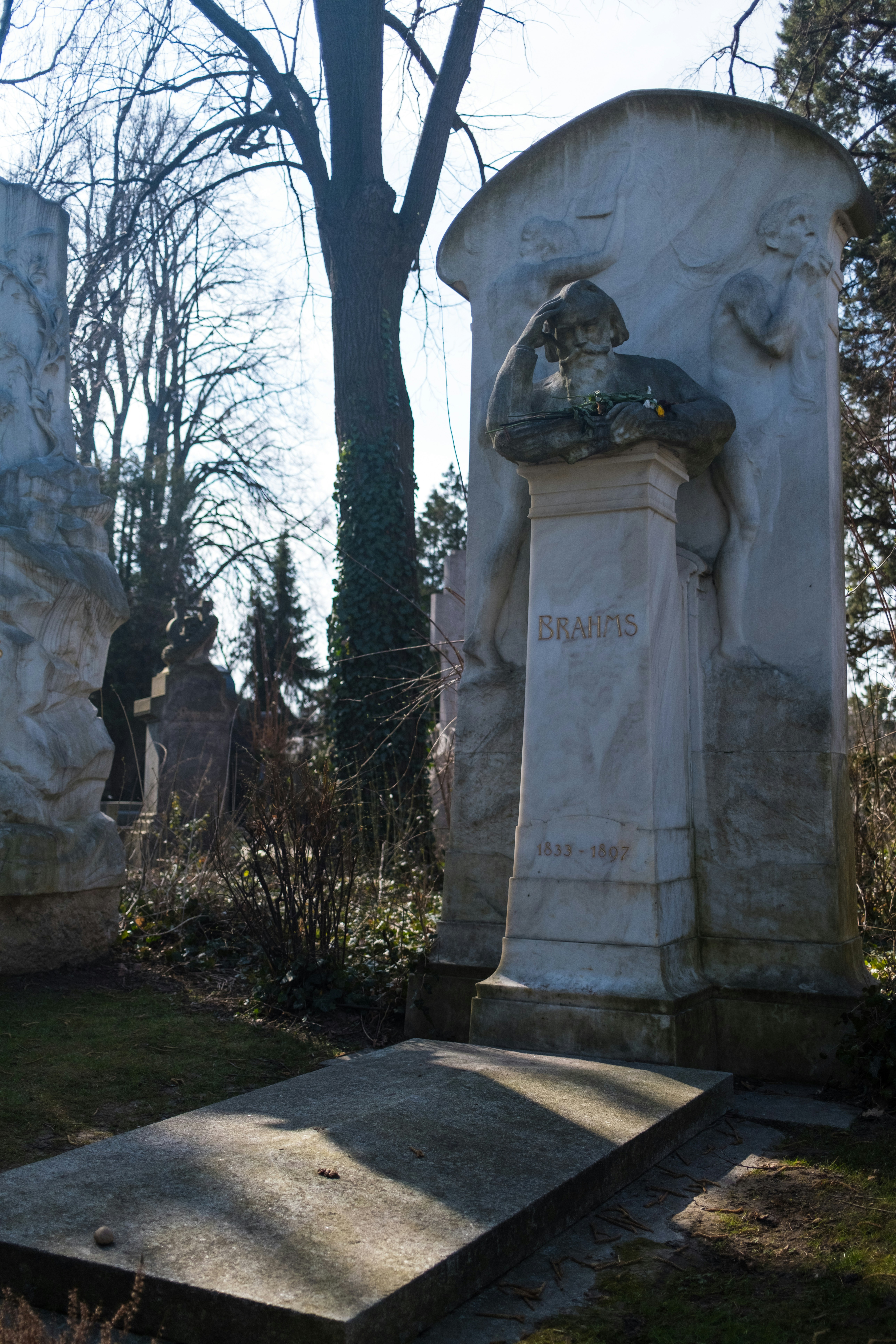 Sculpted Guardian of the Grave: Bust and Column at Resting Place
