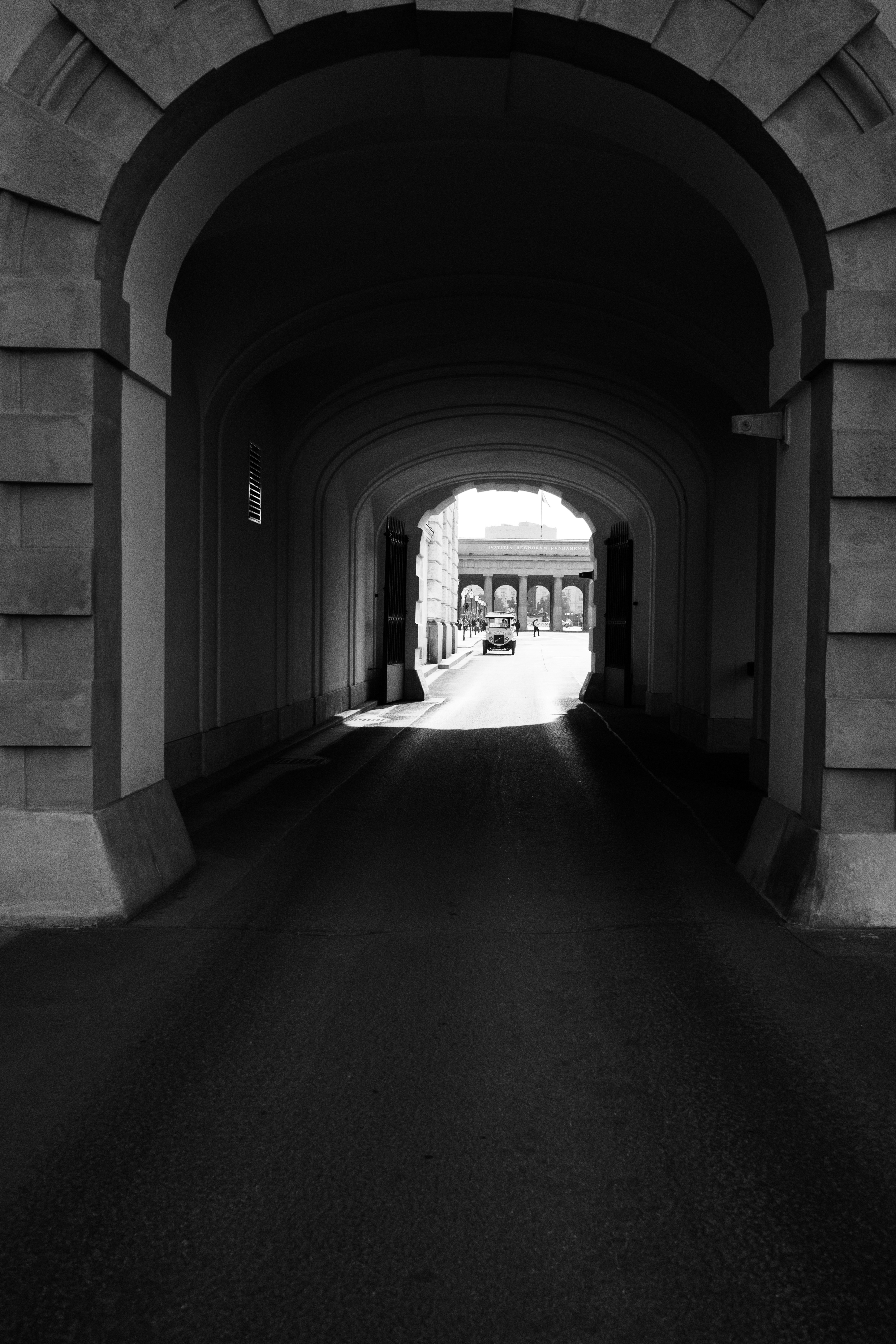 Gateway to Light: Arched Corridor Framing a Distant Street