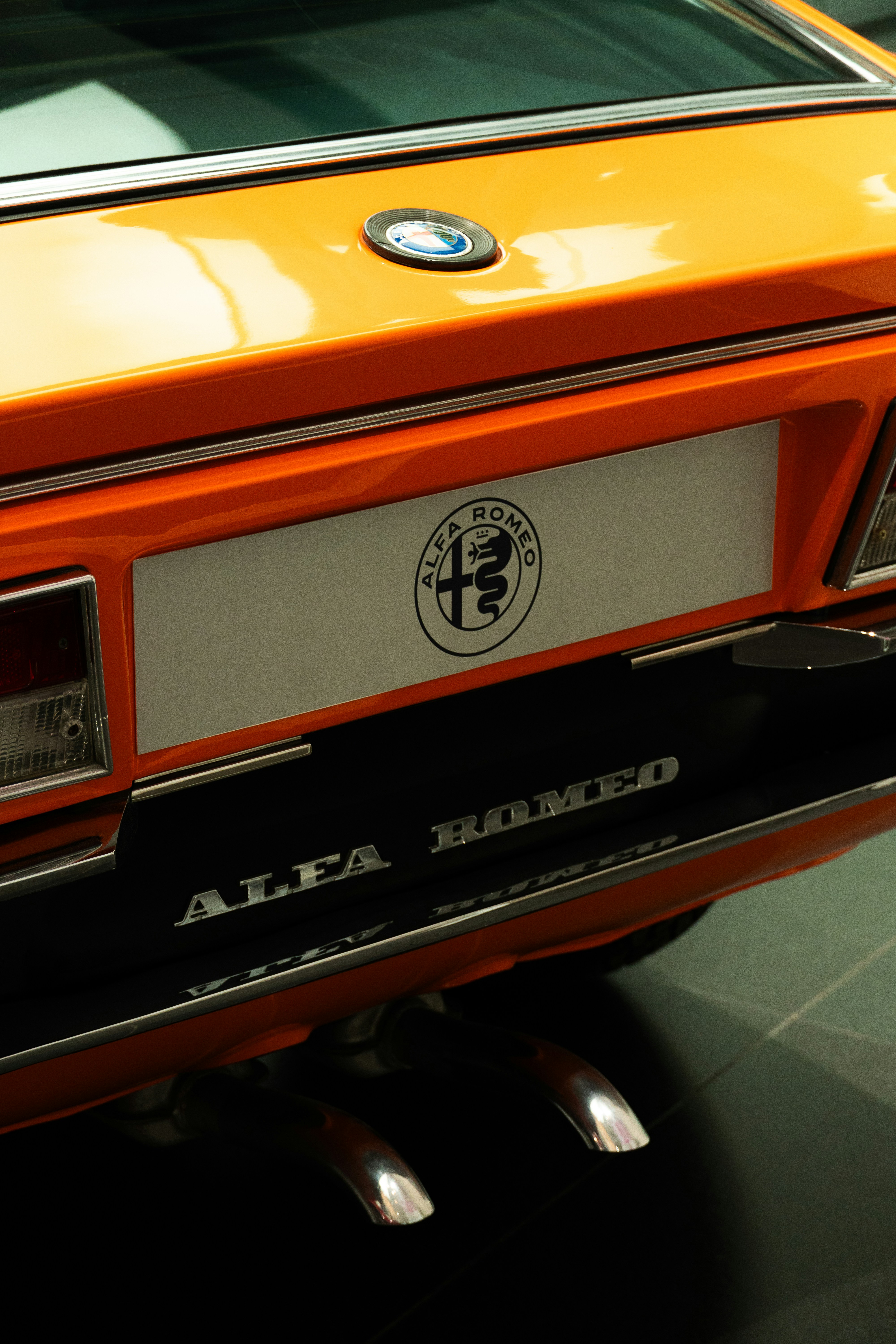 Front-and-Centred Alfa Romeo Badge on a Vivid Orange Classic Car