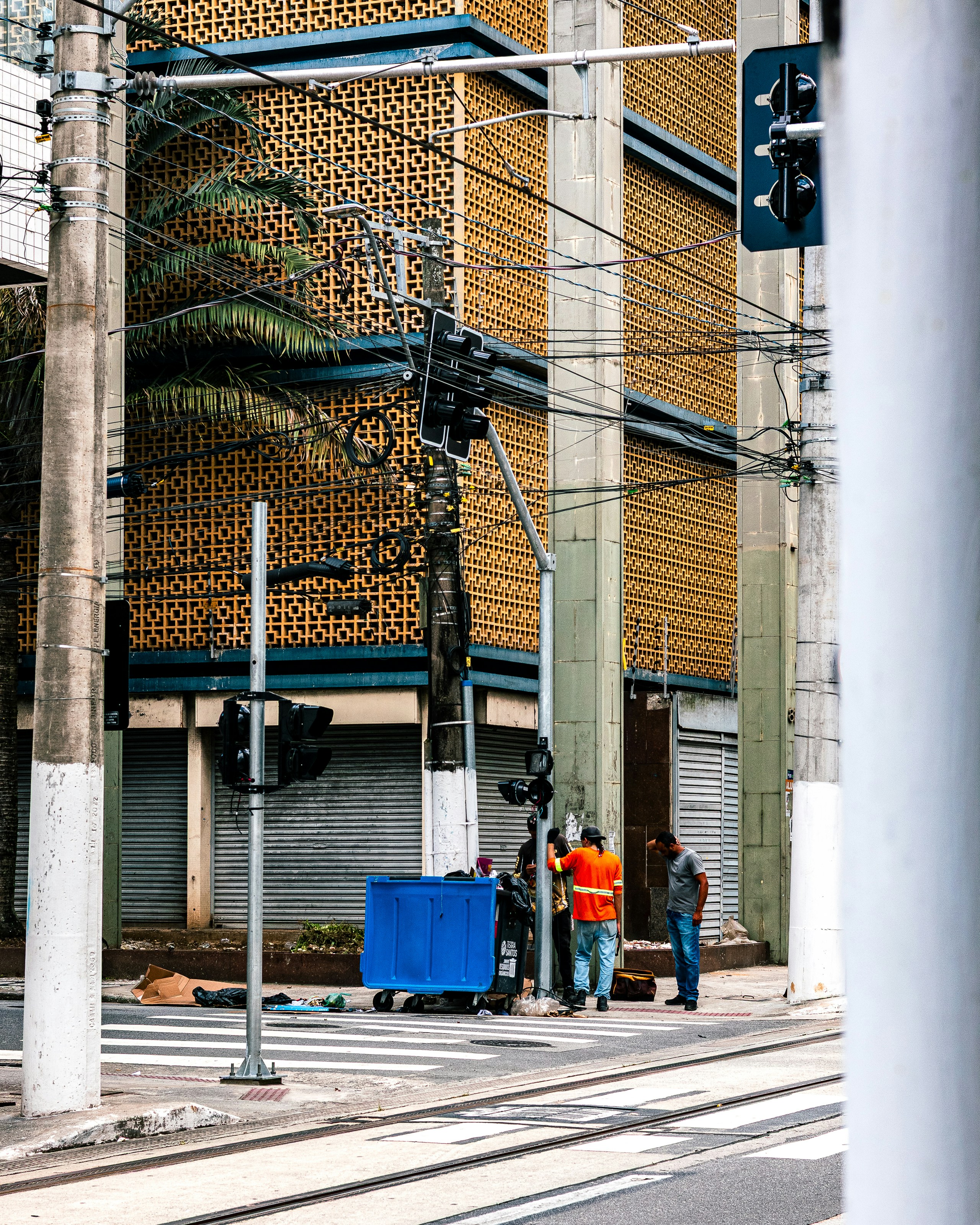 Urban Quiet in the Neon Mesh: Street Crew at the Edge of a Golden Facade