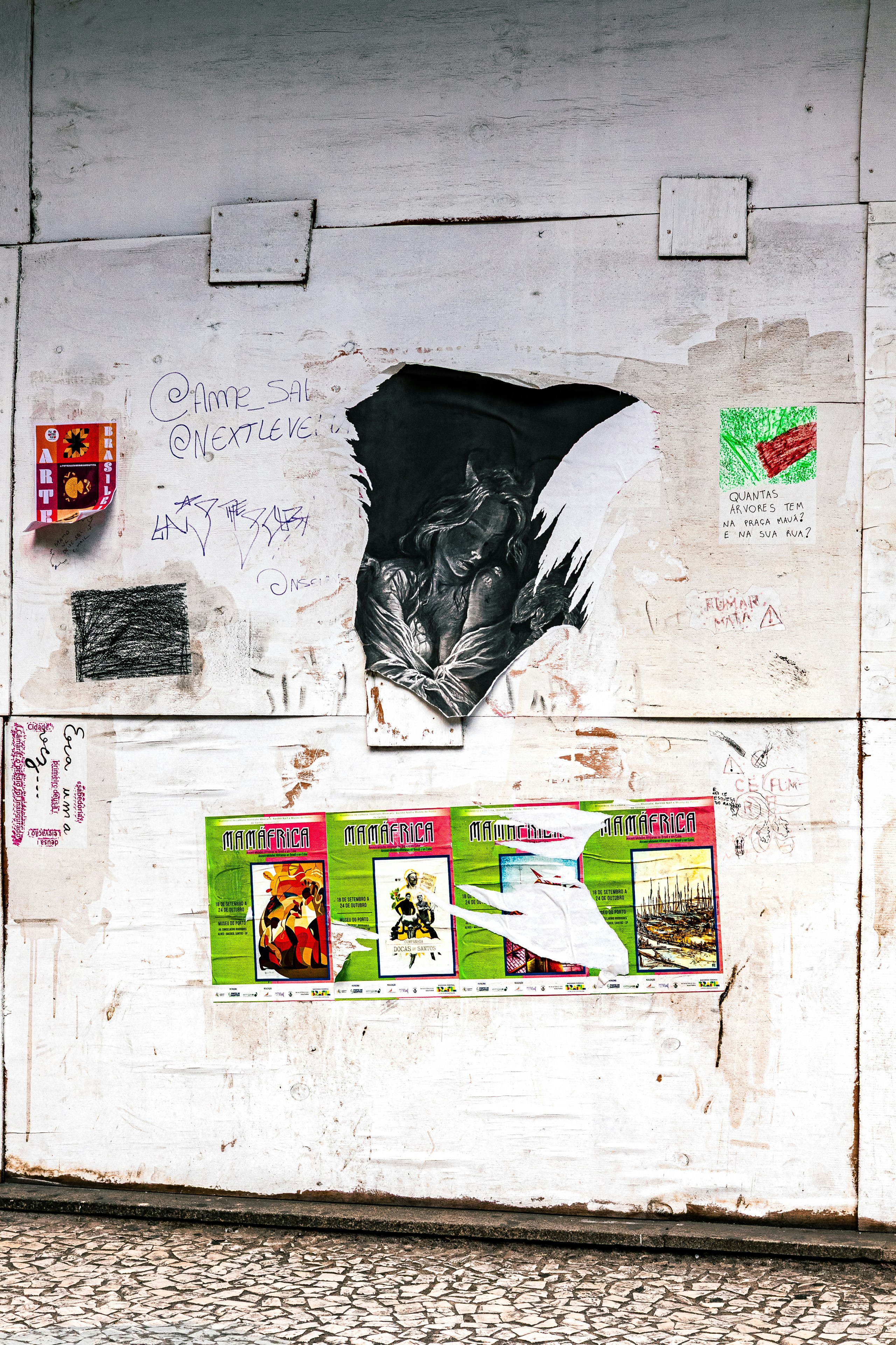 Torn Face in the Urban Wall: A Concrete Mosaic of Posters and Graffiti