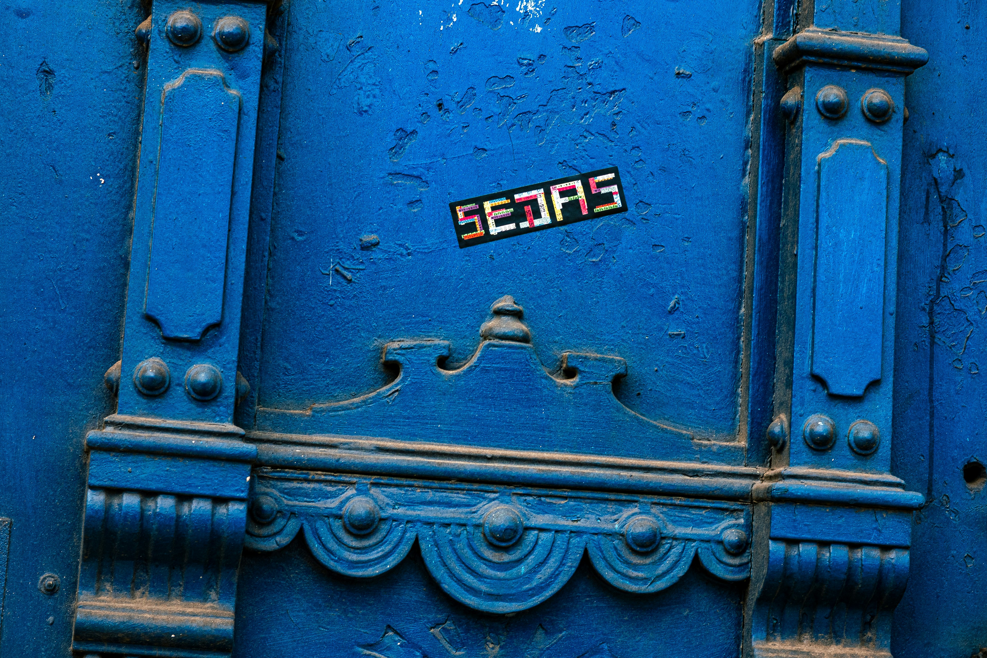 Blue Doorway of Detailing: A Close-Up on Ornate Ironwork