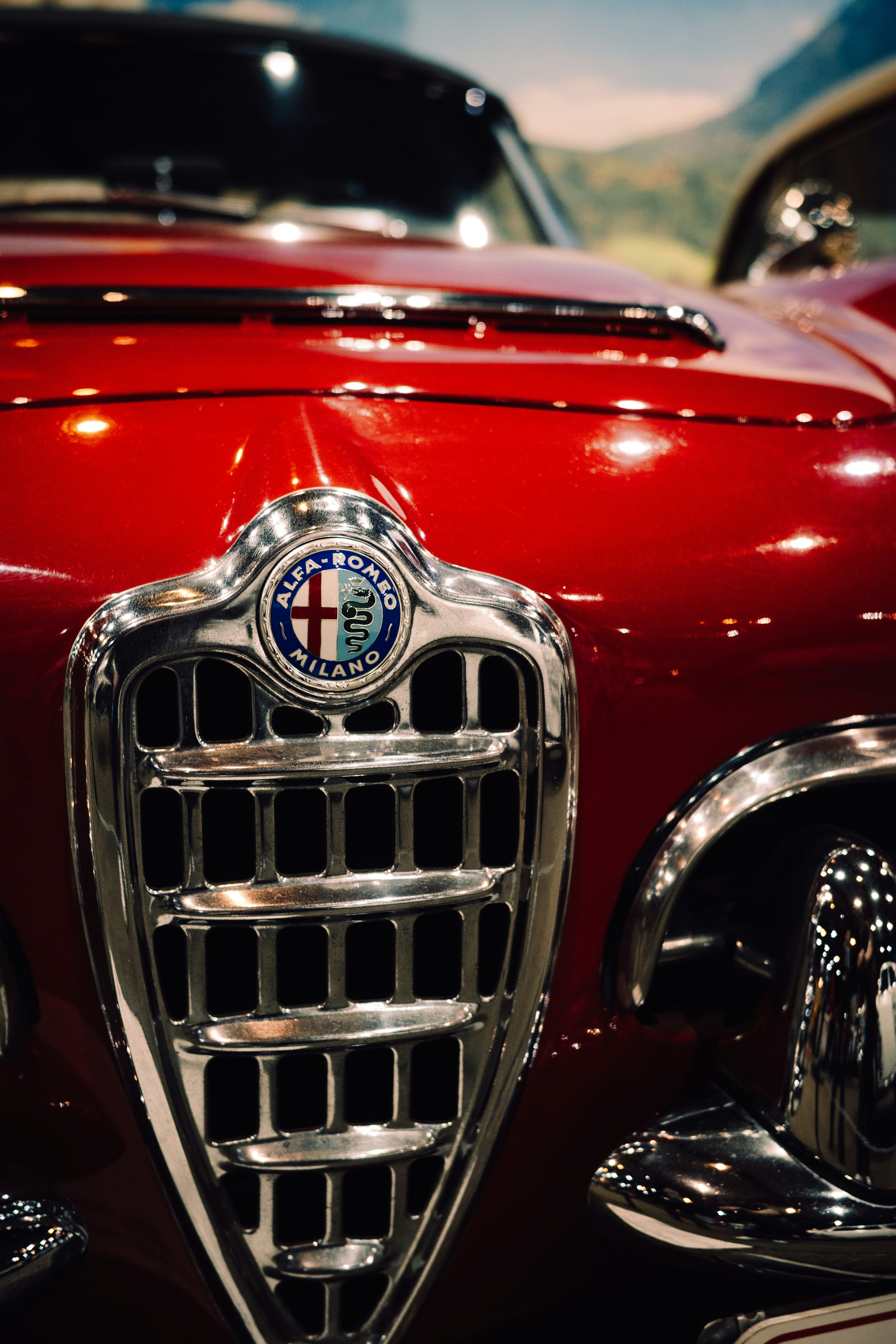Chrome Grille Crown: Alfa Romeo Emblem on a Crimson Classic