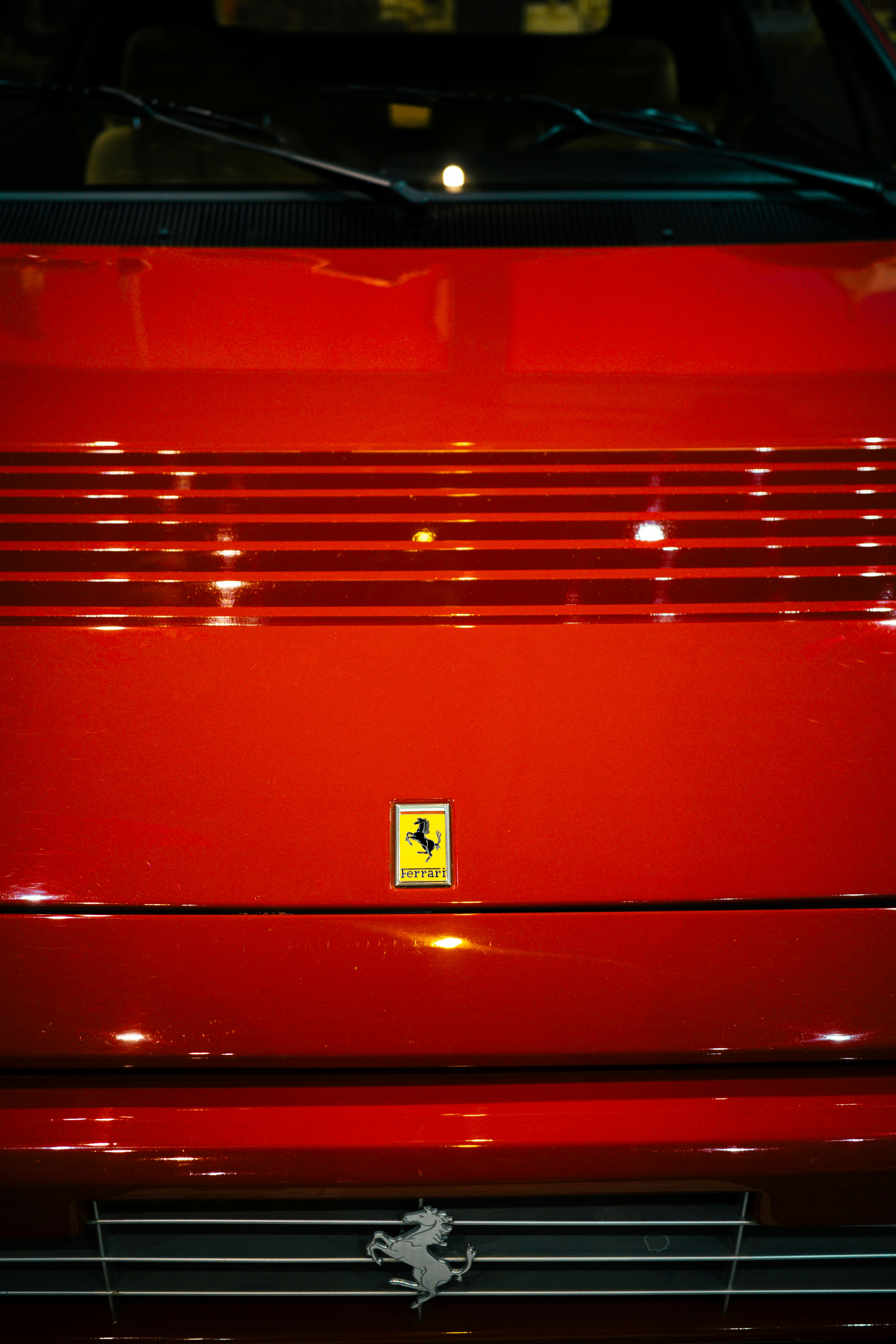 Ferrari Emblem Glow: A Close-Up of Red Car Front
