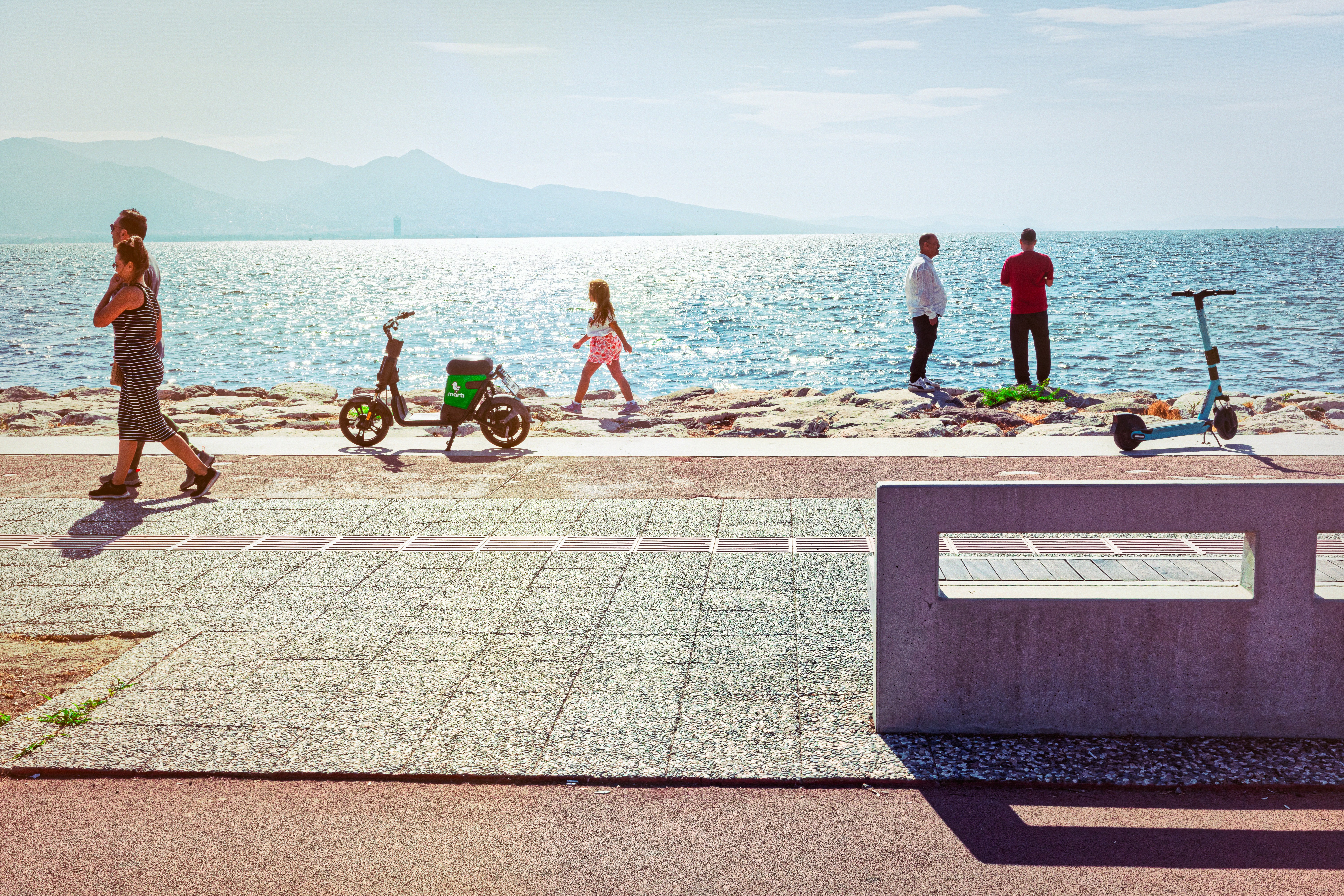 Seaside Walkway: People, Boards, and Bikes Along the Breakwater