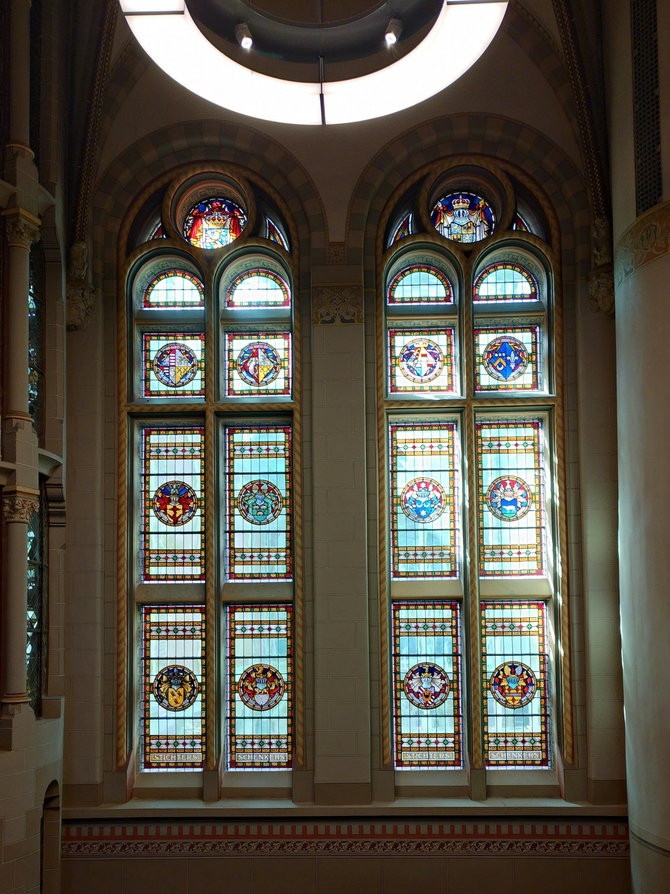 Stained Glass Cathedral Windows Framed by Arched Pillars