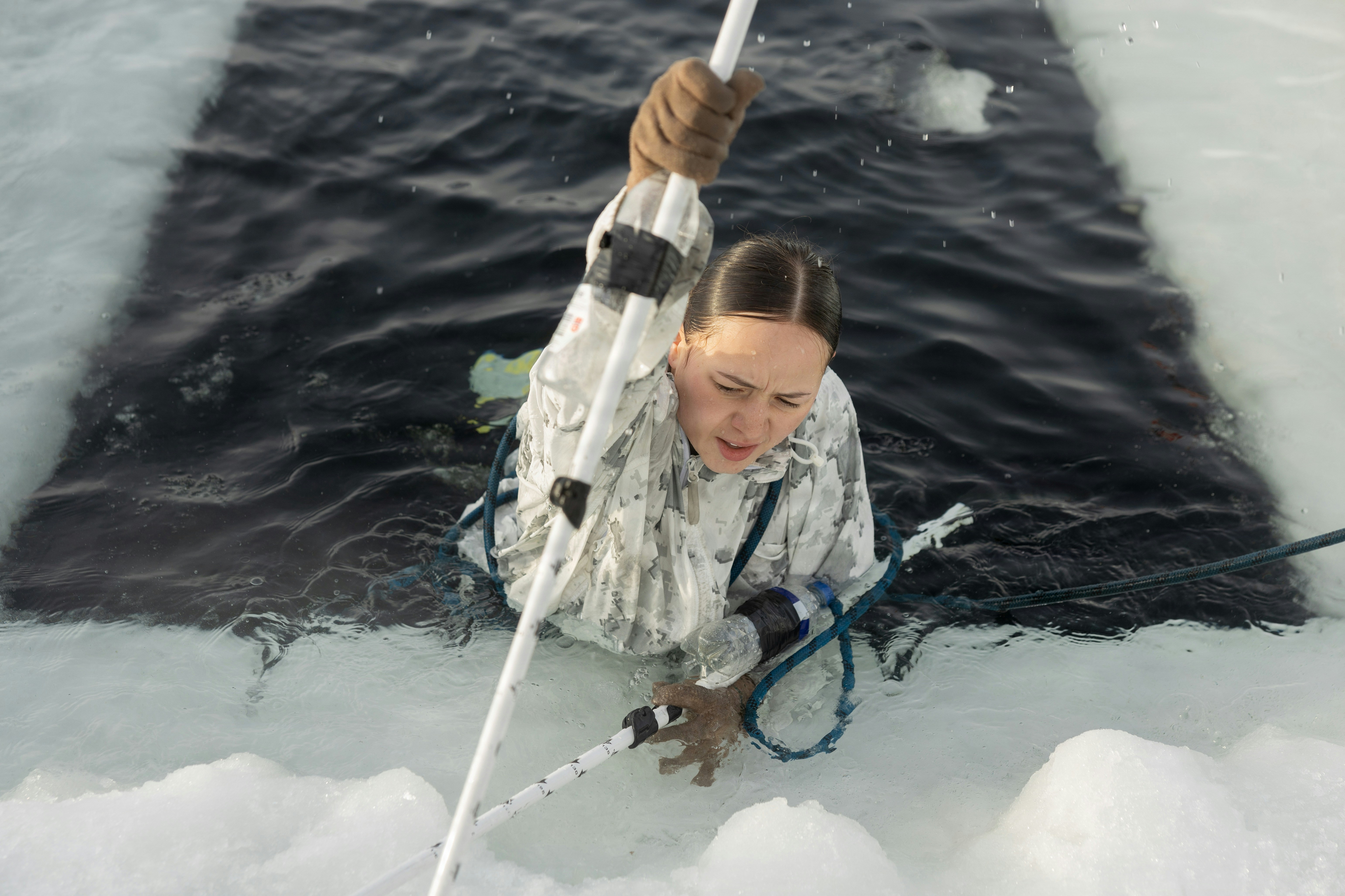 Climber Pauses Above a Narrow Crevasse, Rope Handline Securing the Descent