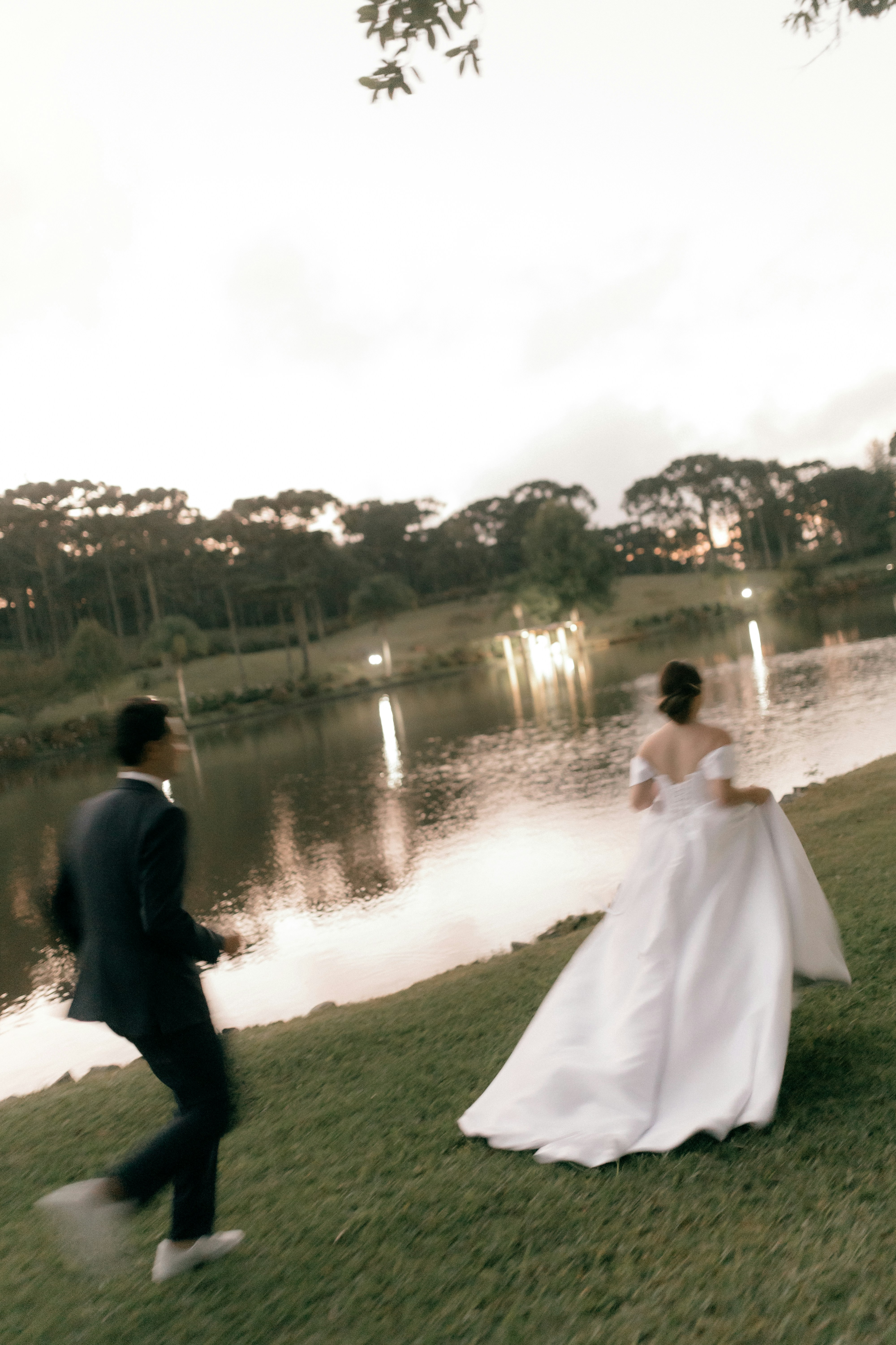 Two Figures in Motion by the Lake: A Wedding Exit in Soft Focus