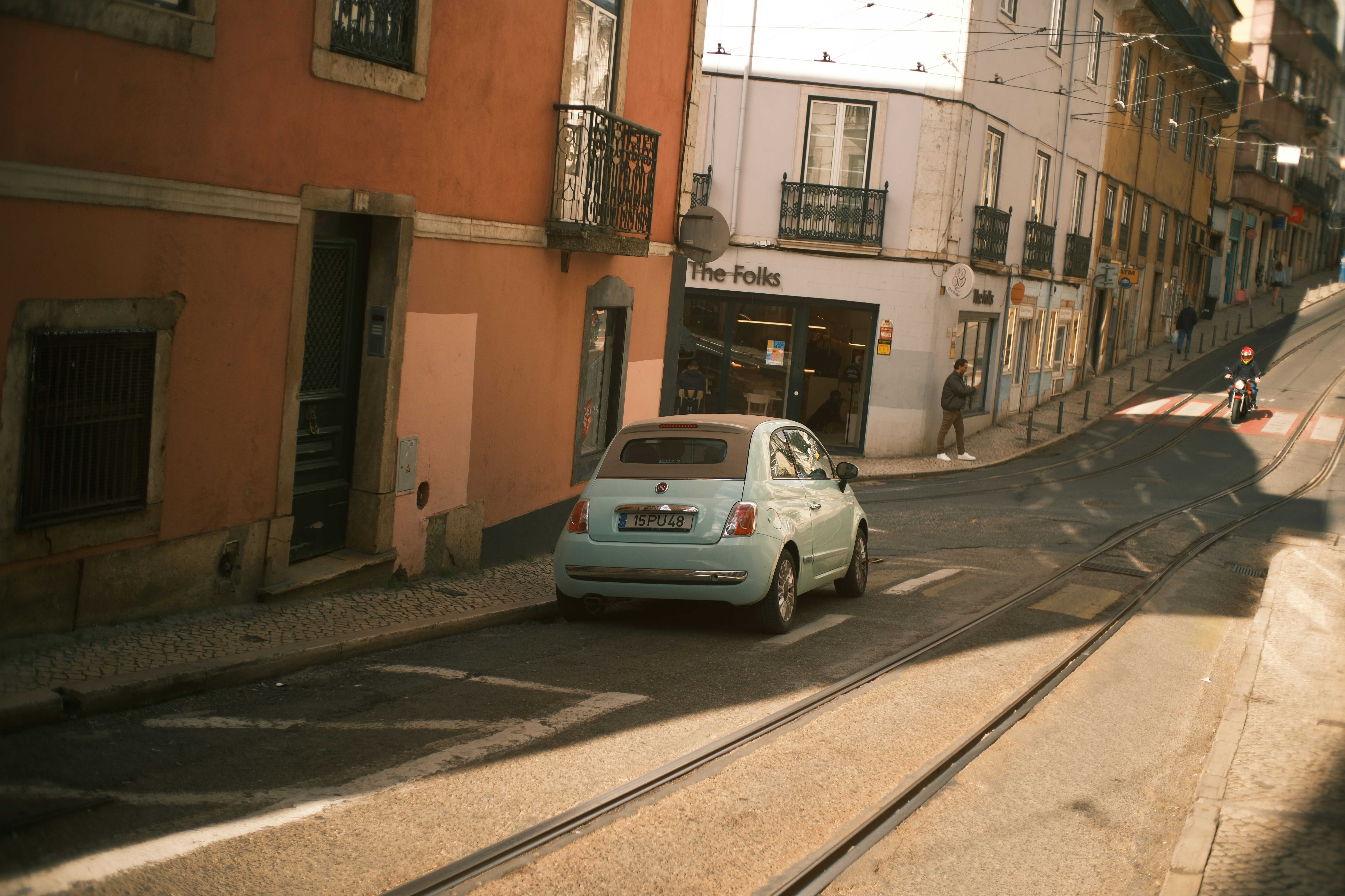 Mint Green Car on a Sunlit European Street