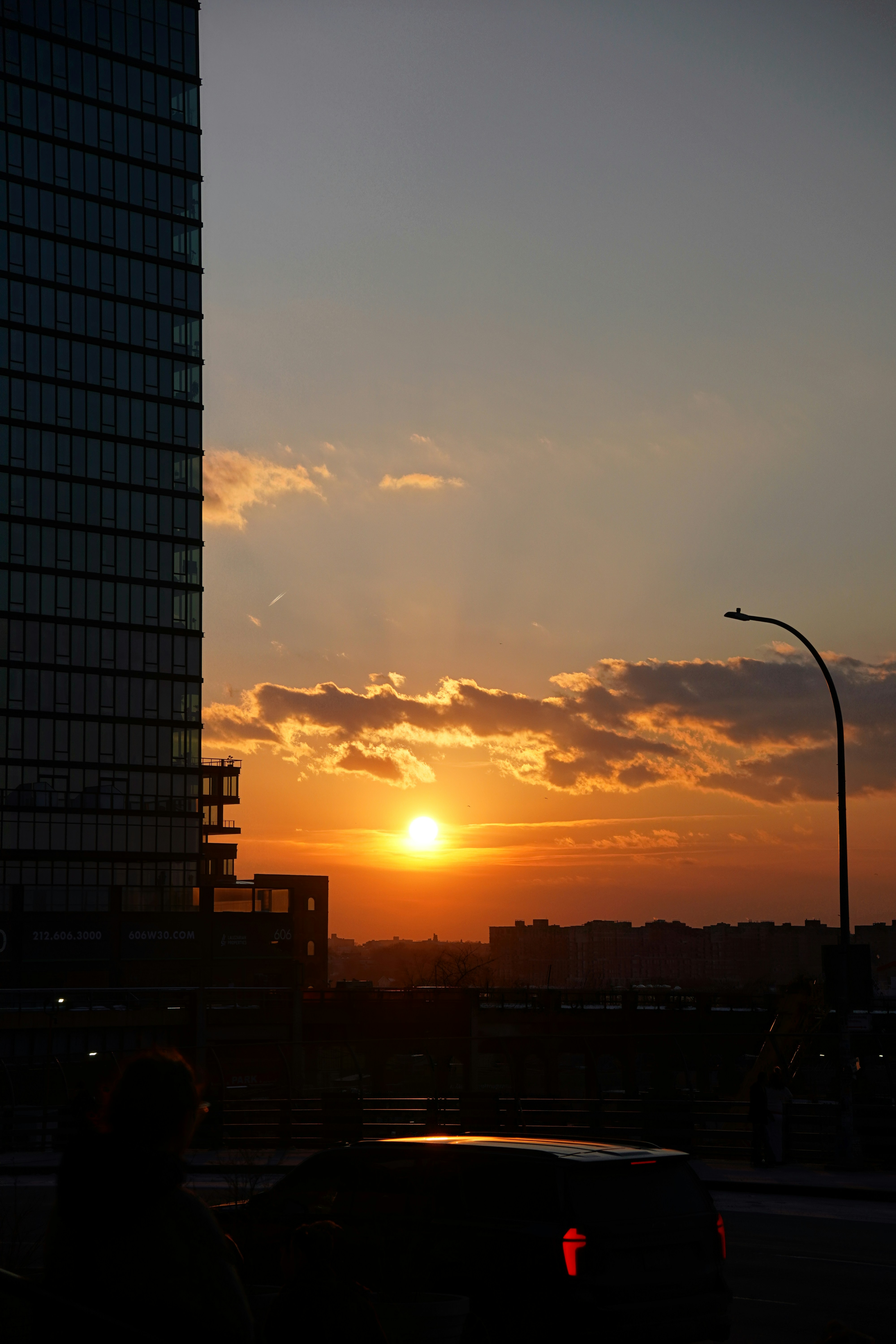 Sunset Over the City: Silhouettes and a Flicker of Light
