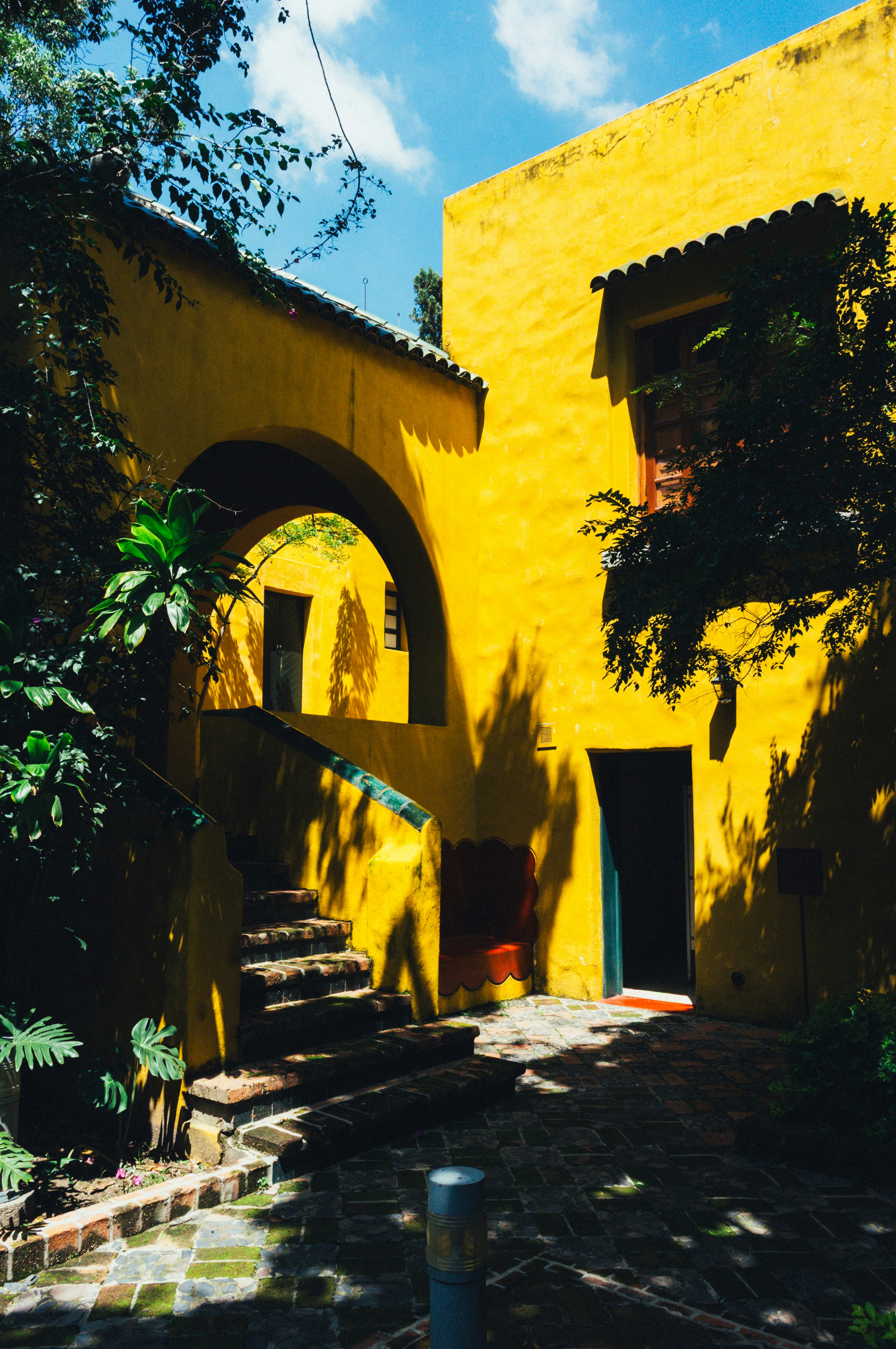 Sunlit Arch and Yellow Courtyard: A Quiet Mexican-Color Oasis