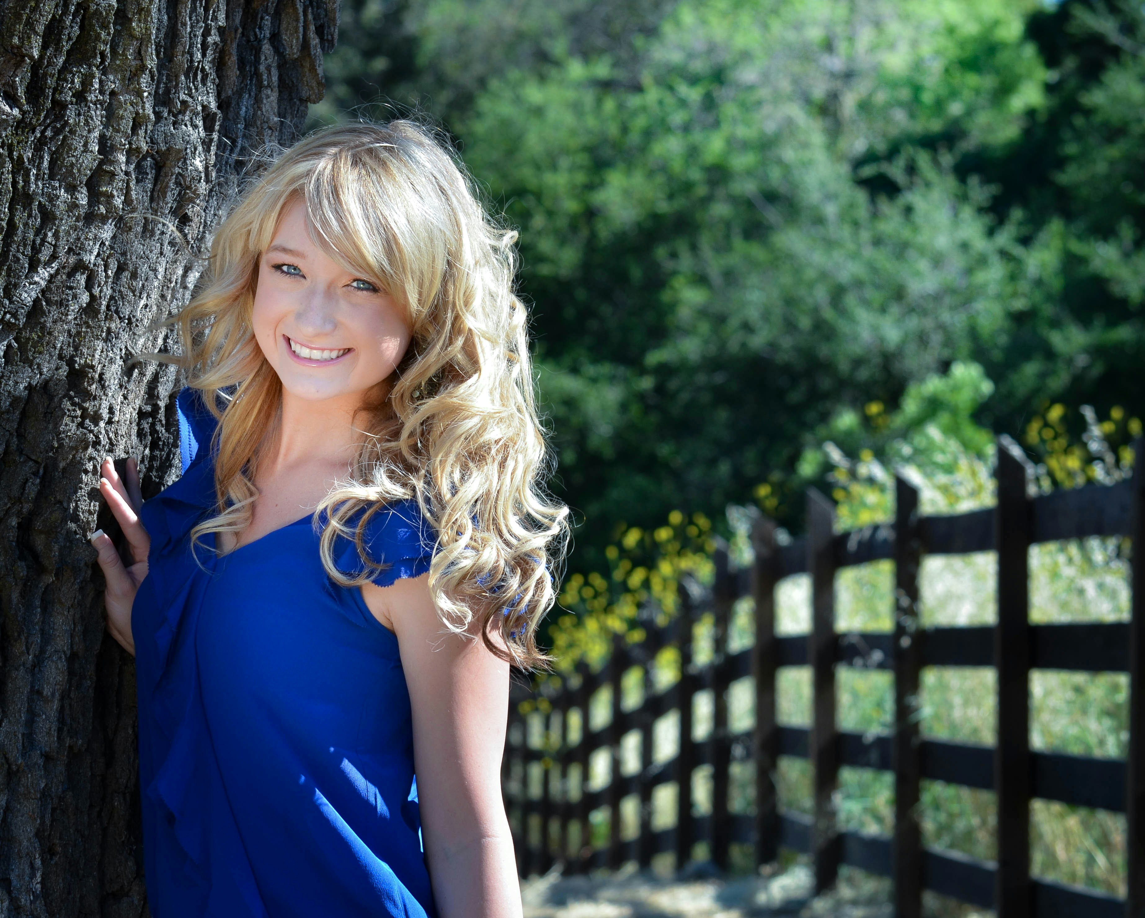 Sunlit Smile by the Weeping Willow Fence