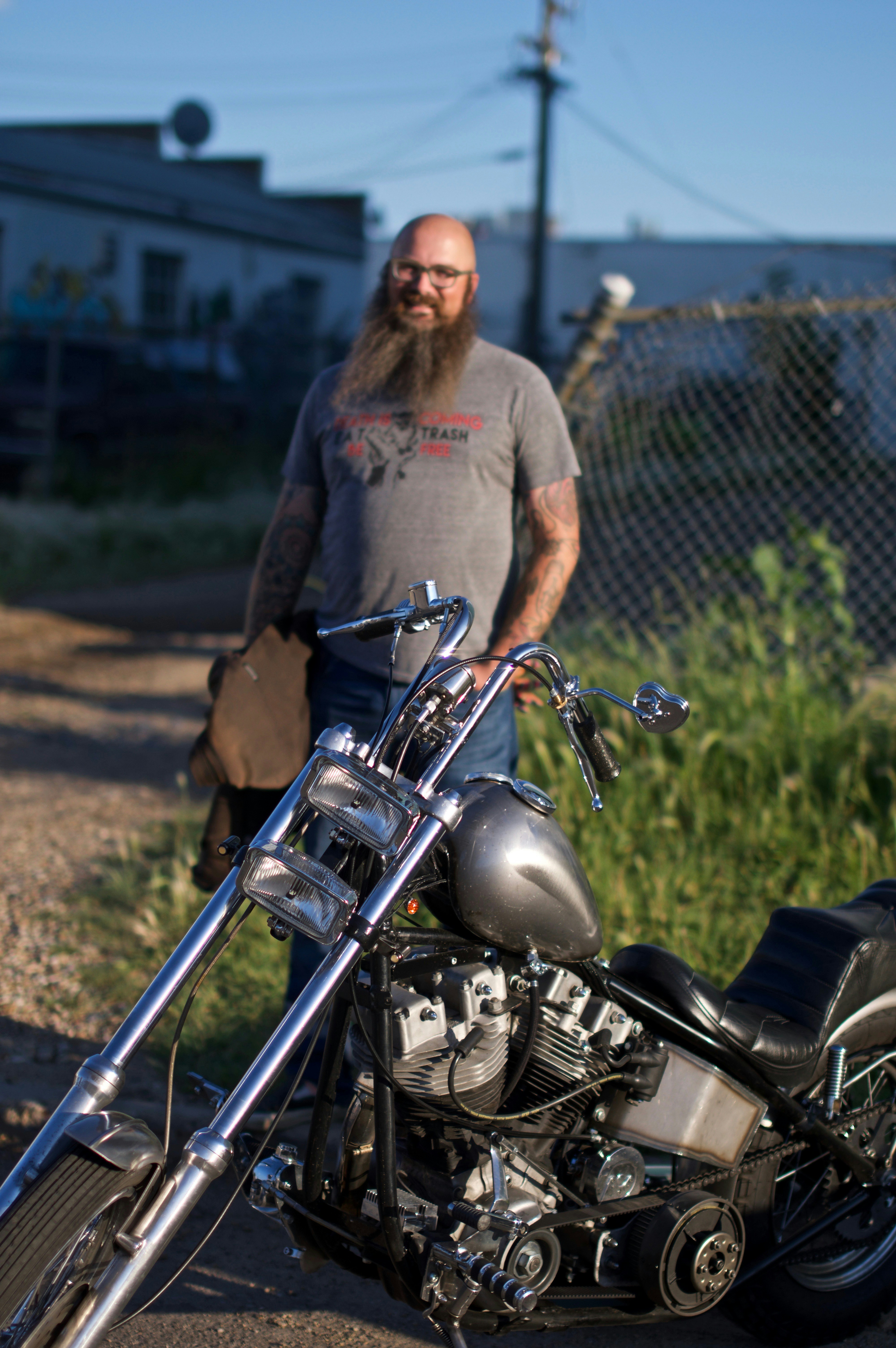 Beard and bike: a sunlit stand by the chrome engine