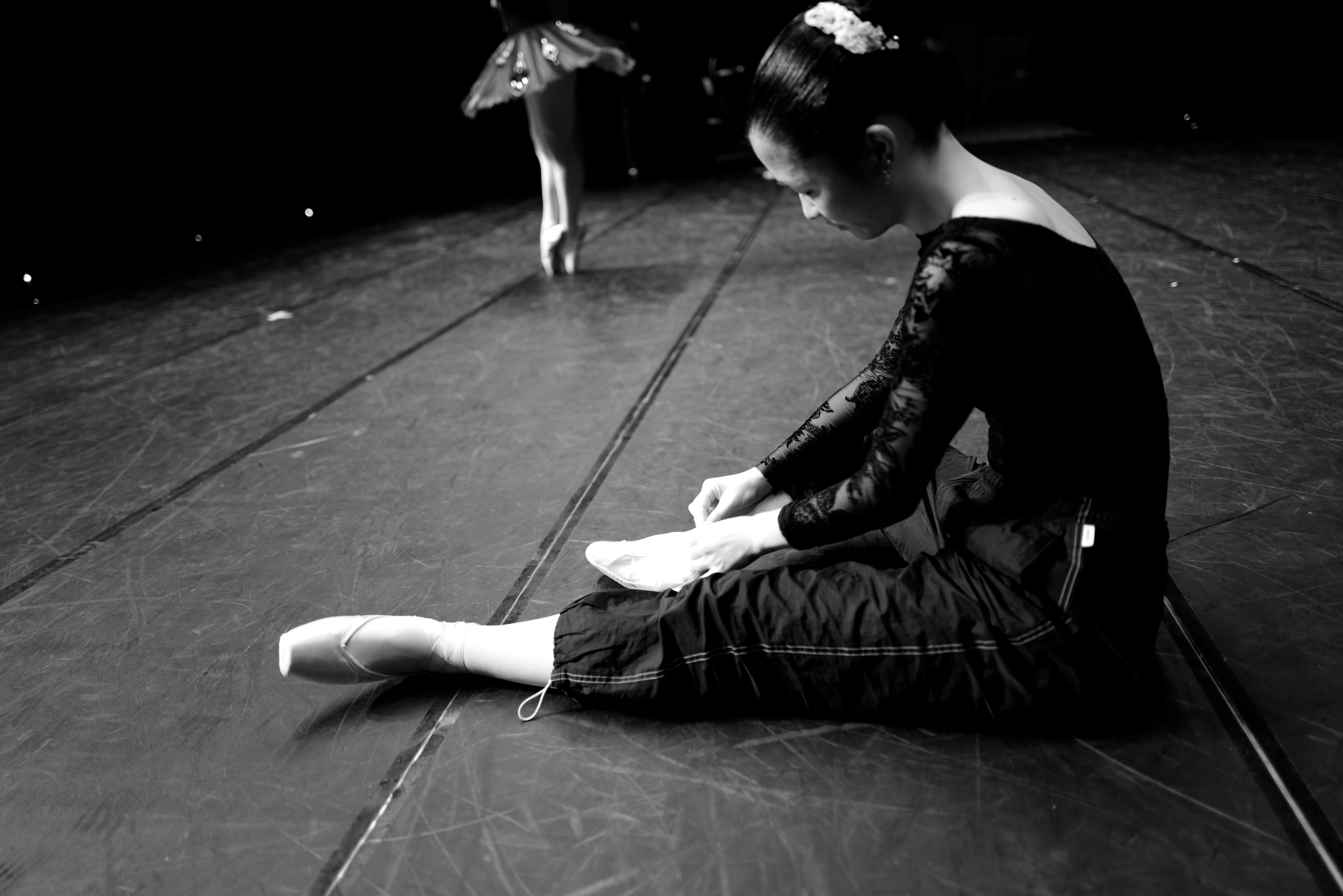 Silent Rehearsal: A Dancer Pauses in Warmth of Onstage Light