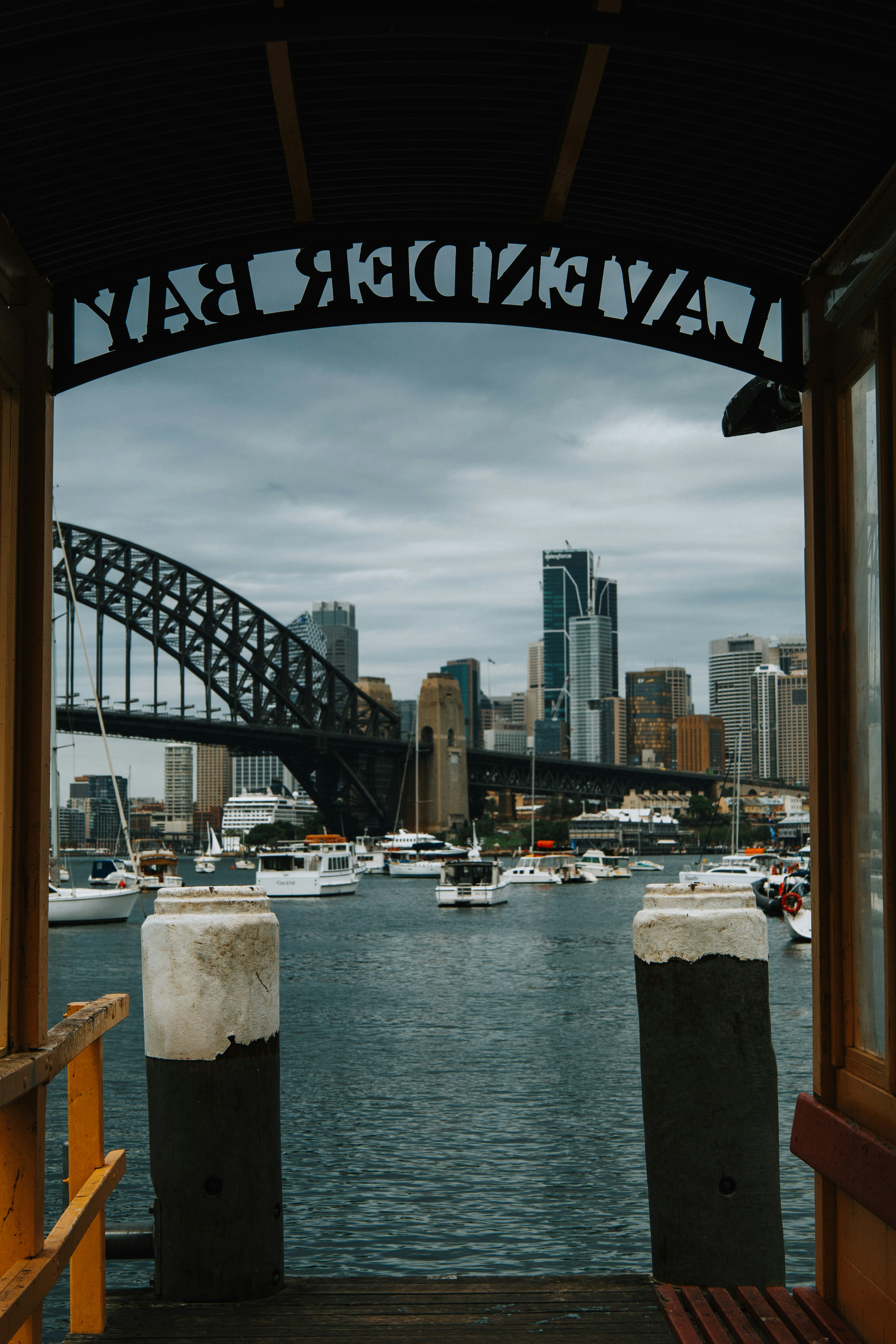 Harbor Entrance: Sydney-like scene framed by a pavilion with a distant skyline