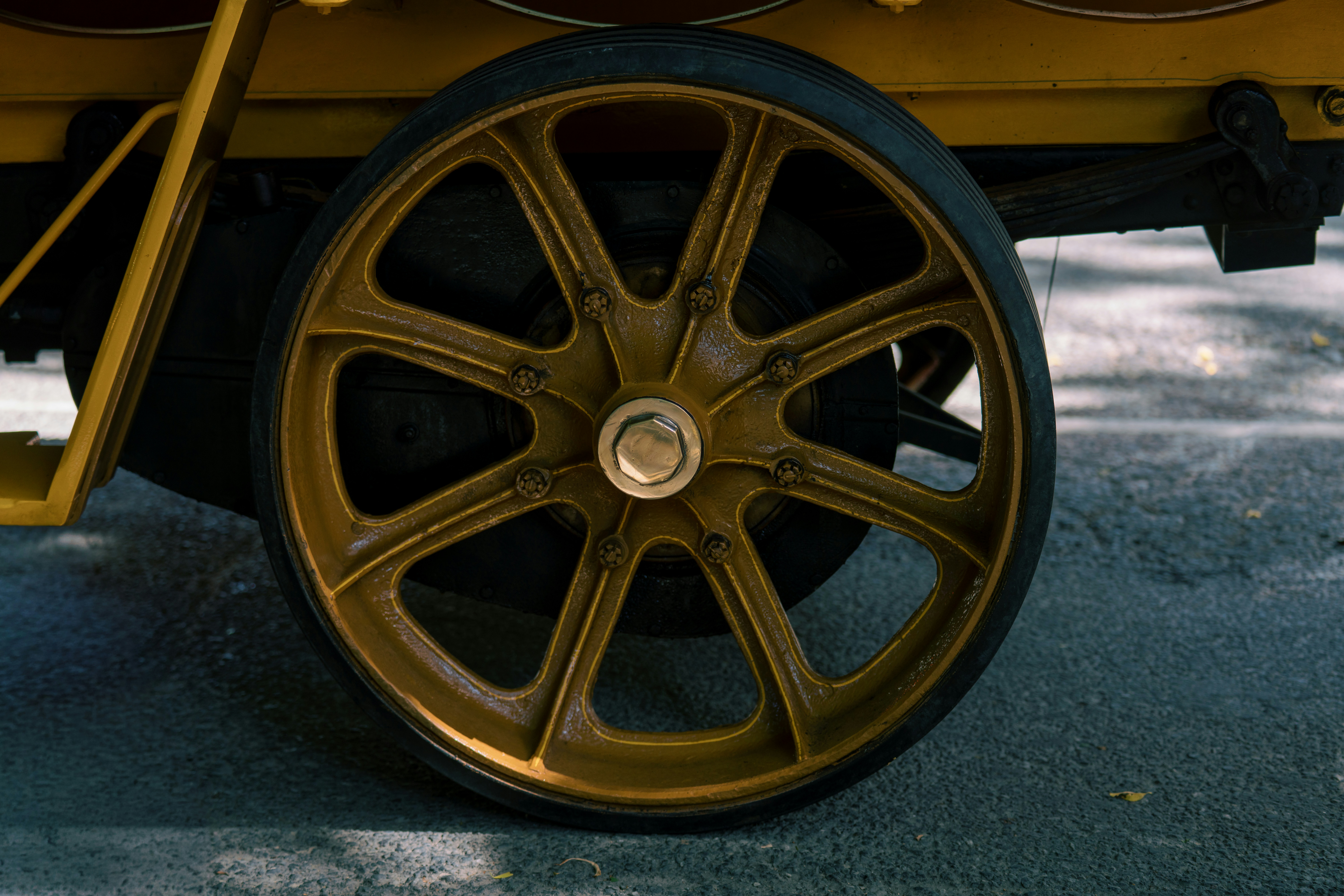 Gilded Wheel Underbelly: A Close-Up of Vintage Train Railcar Power
