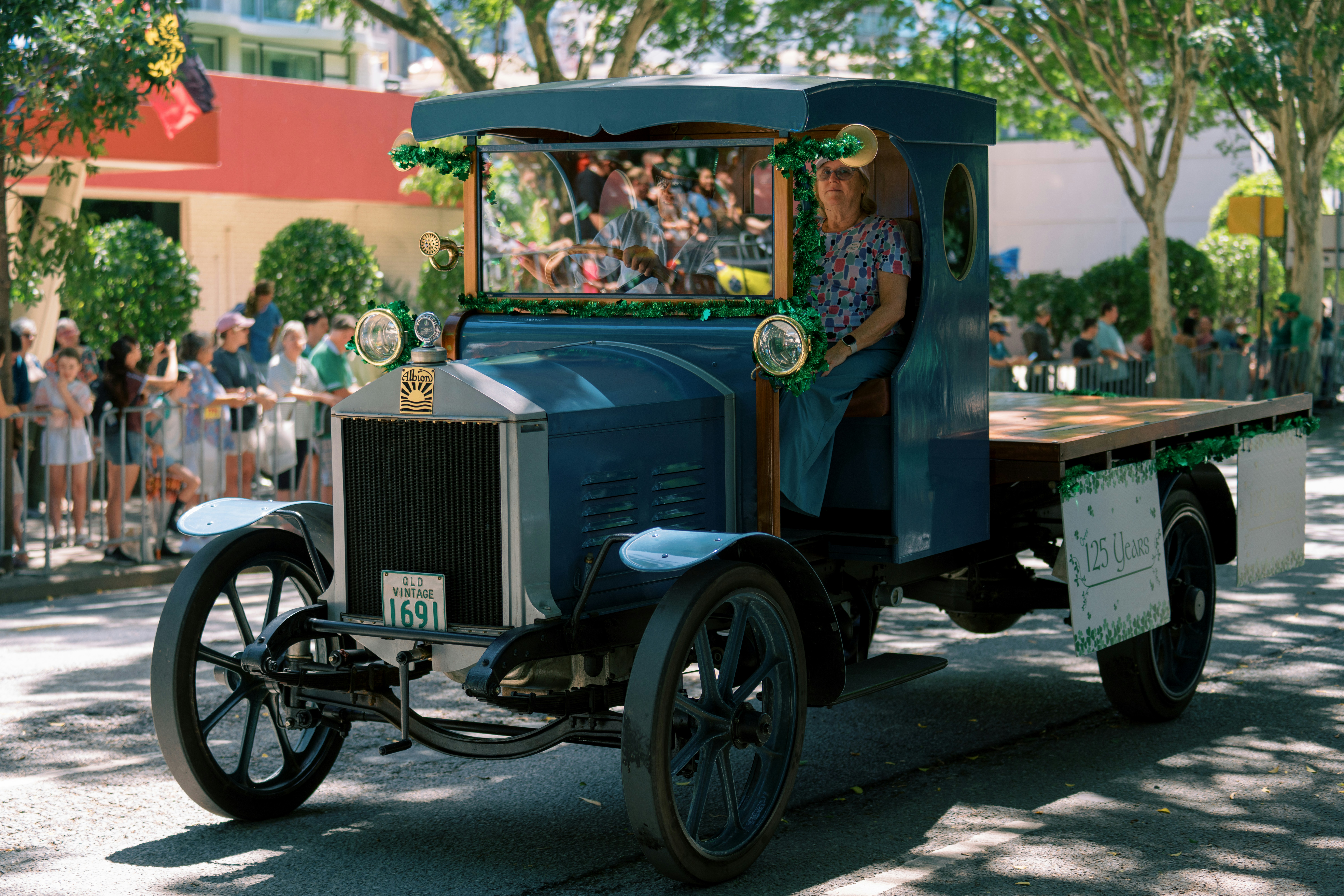 Blue Vintage Truck Parade: A Crowded Street, Gentlemen and Gasoline