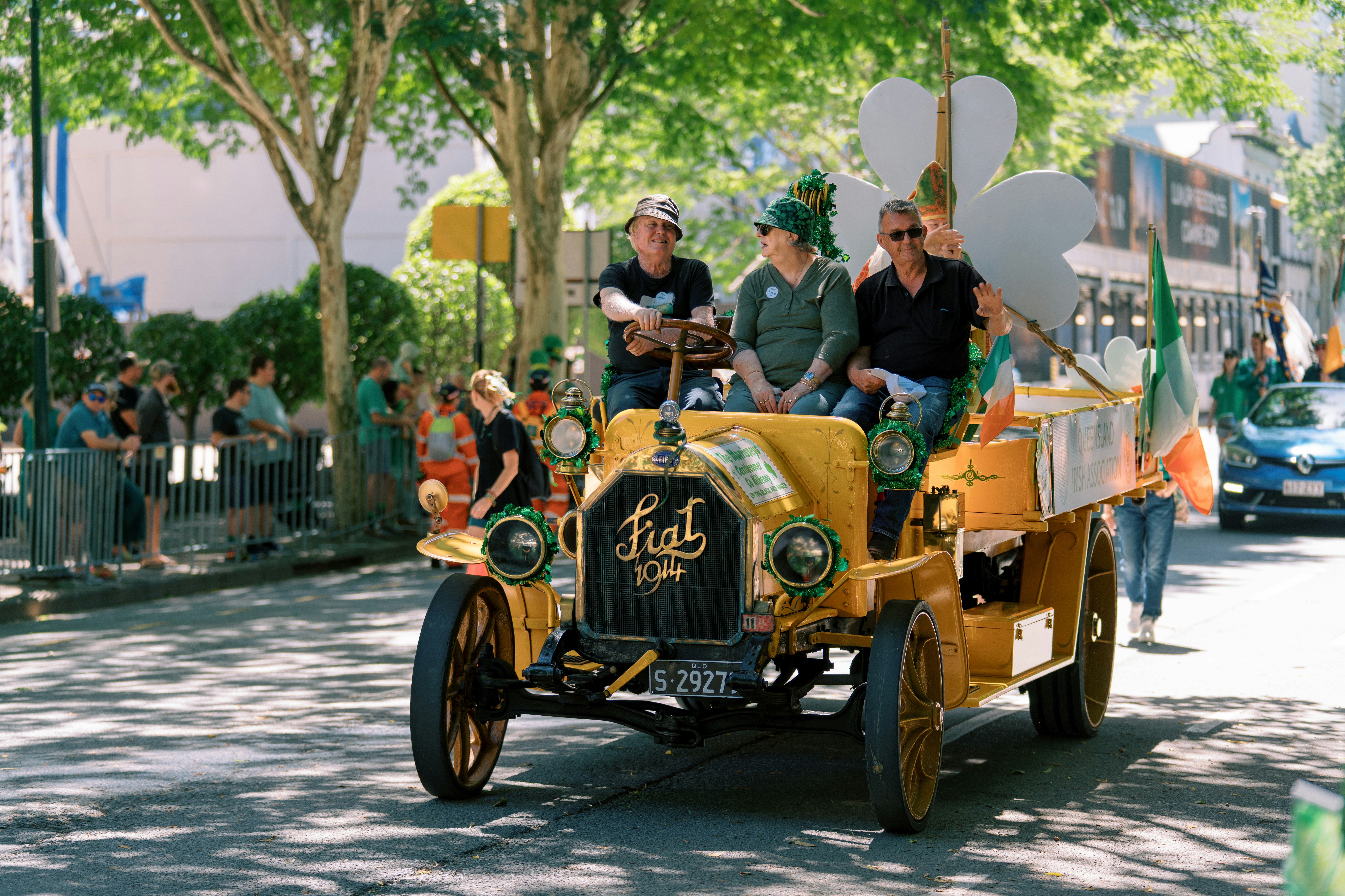 Golden Parade: Vintage Car with Balloon Crew Leads the Street Festival