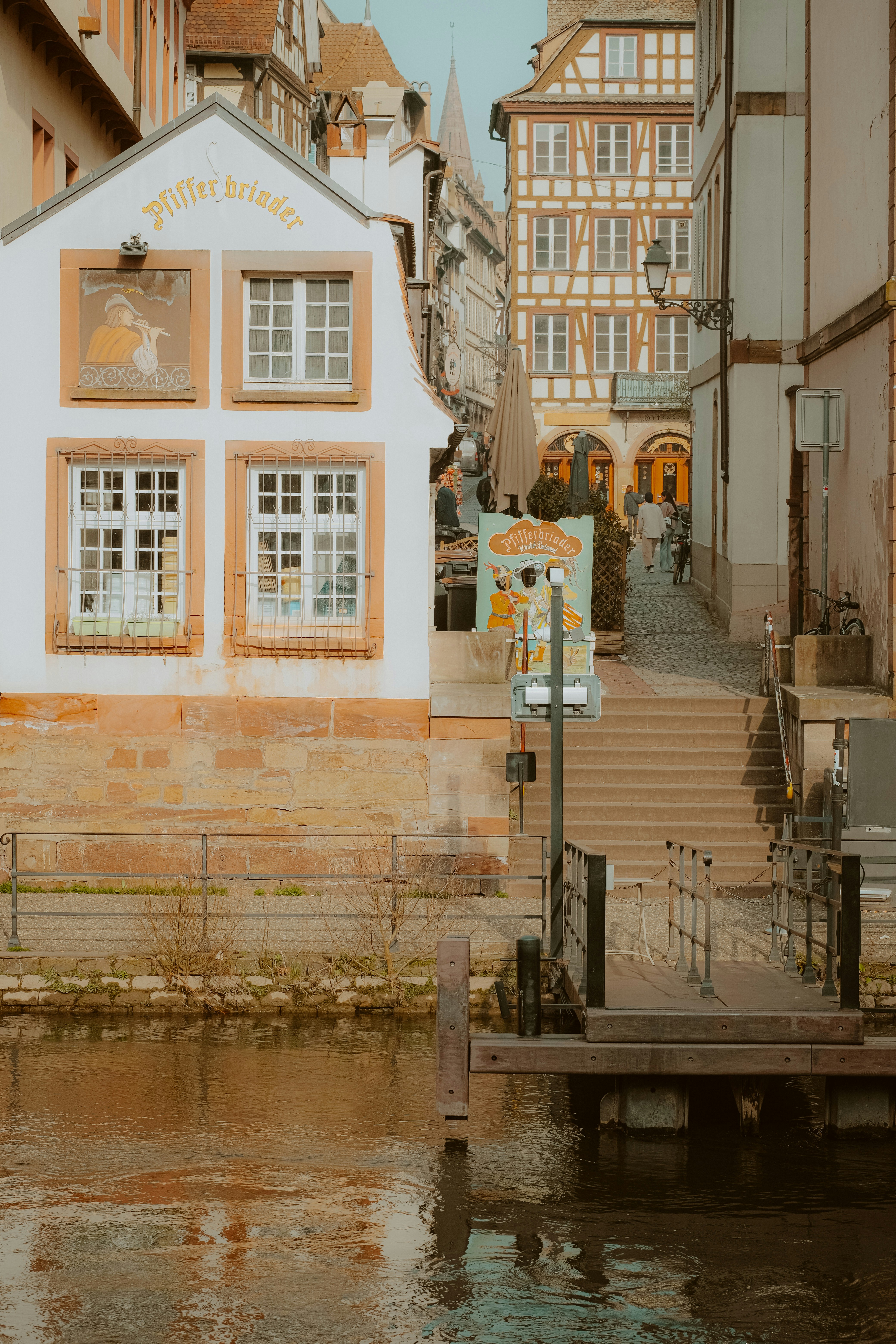 Pierside Passage: Timbered Facades and Waterfront Stairway