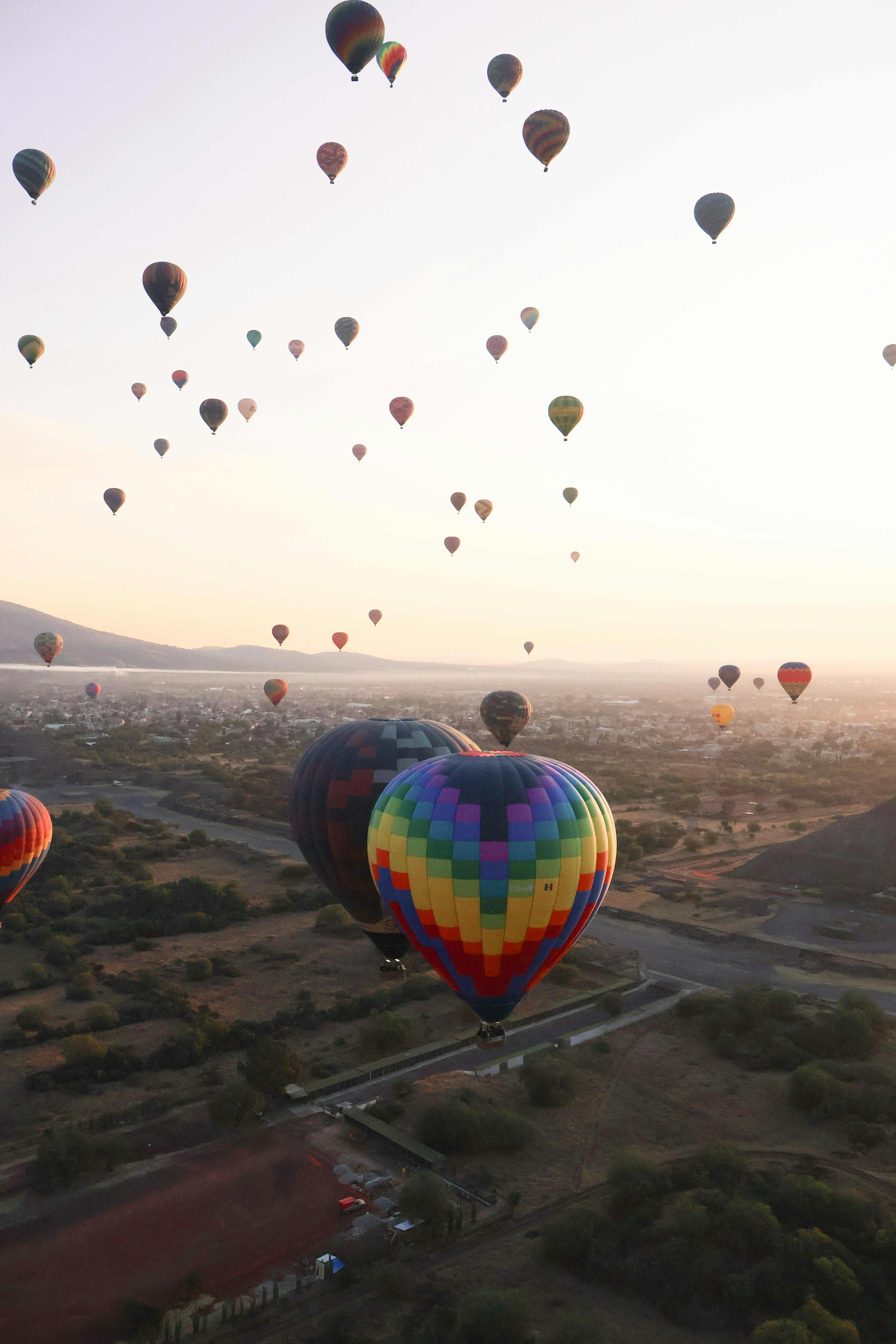 Colorful Heart Above the Plains: Hot Air Balloons in Dawn Light