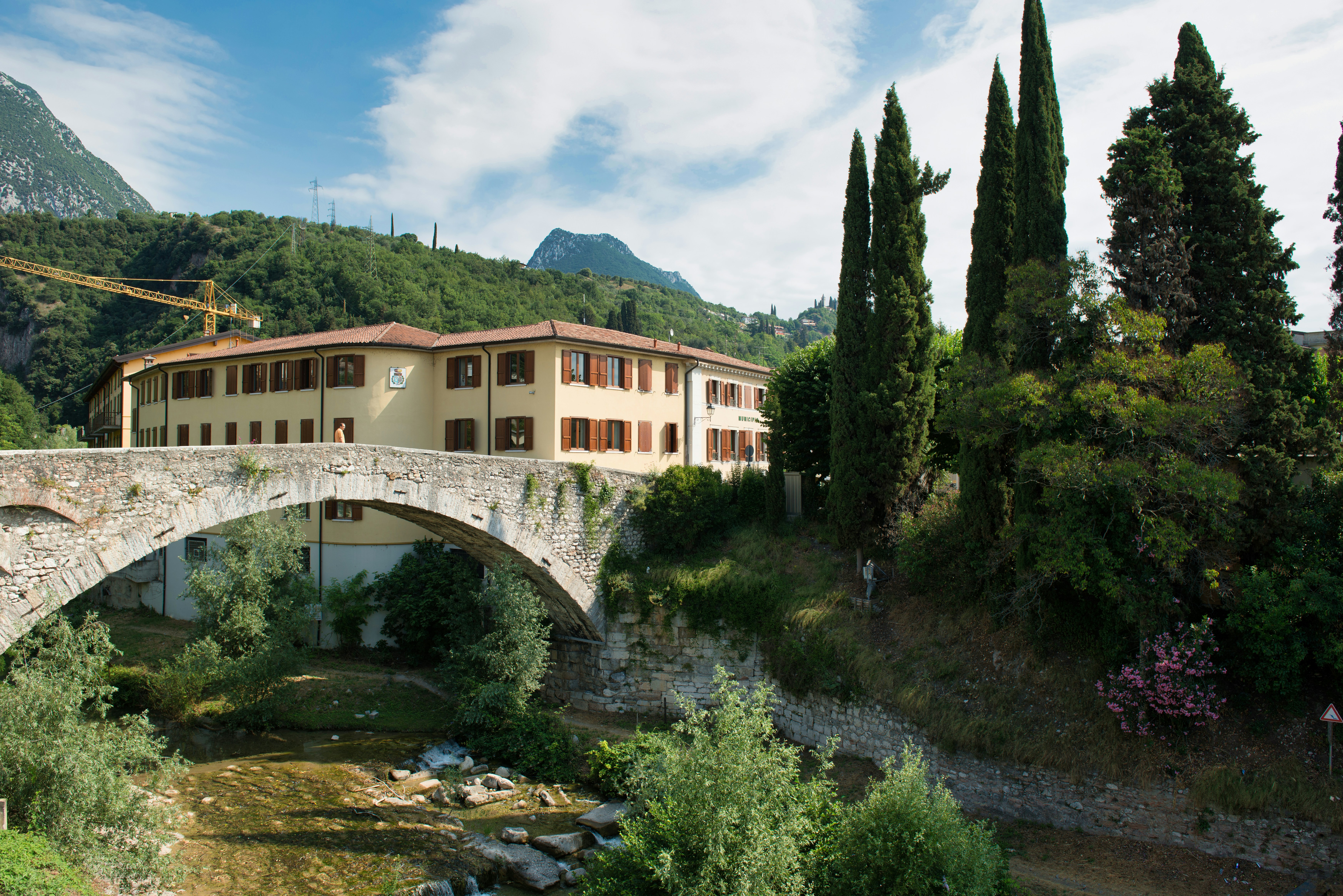 Stone Bridge Over Tidy Carved Waters: Alpine Village Scene