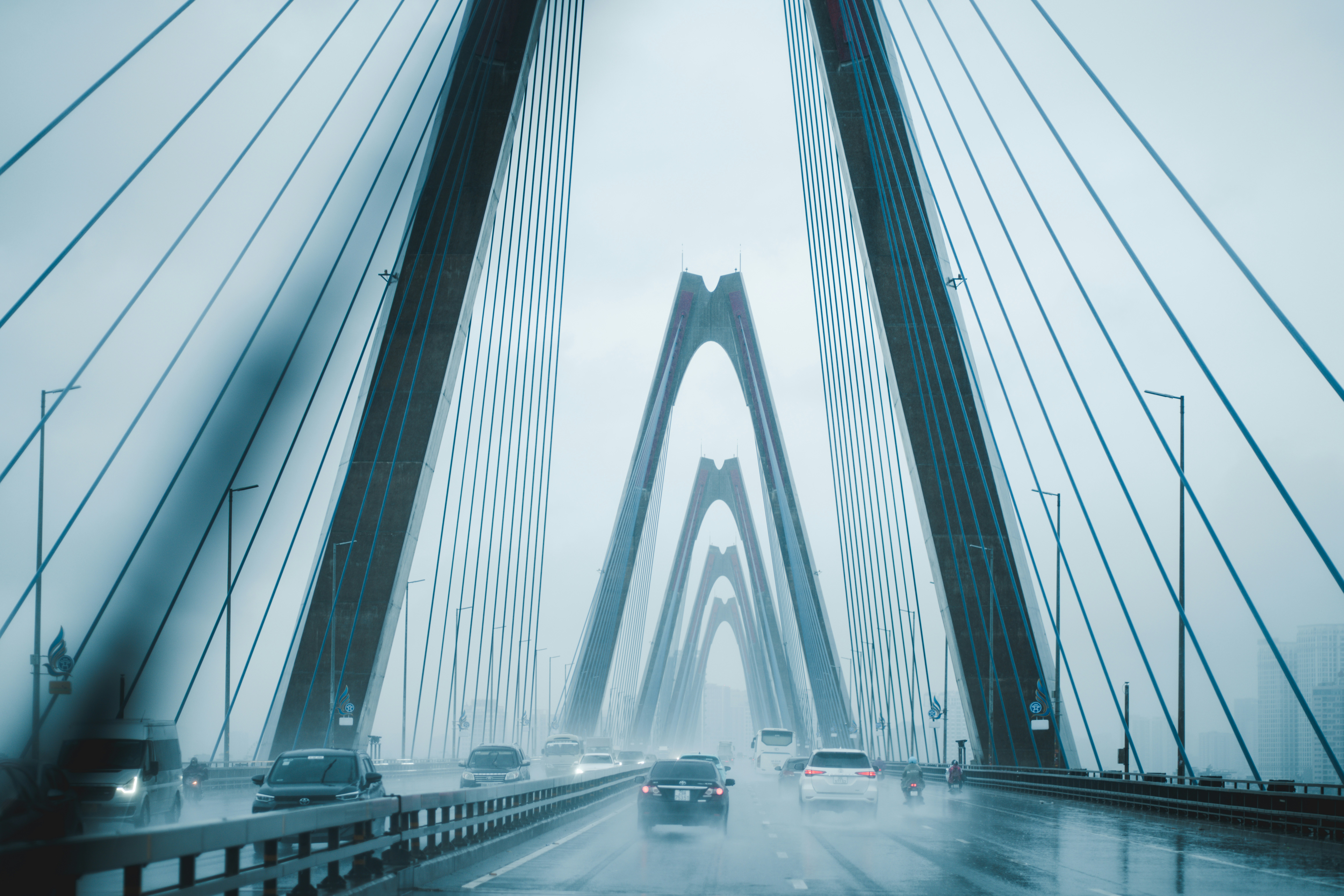 Overcast Arches: A Rainy Ride Across the Cable-Strewn Span