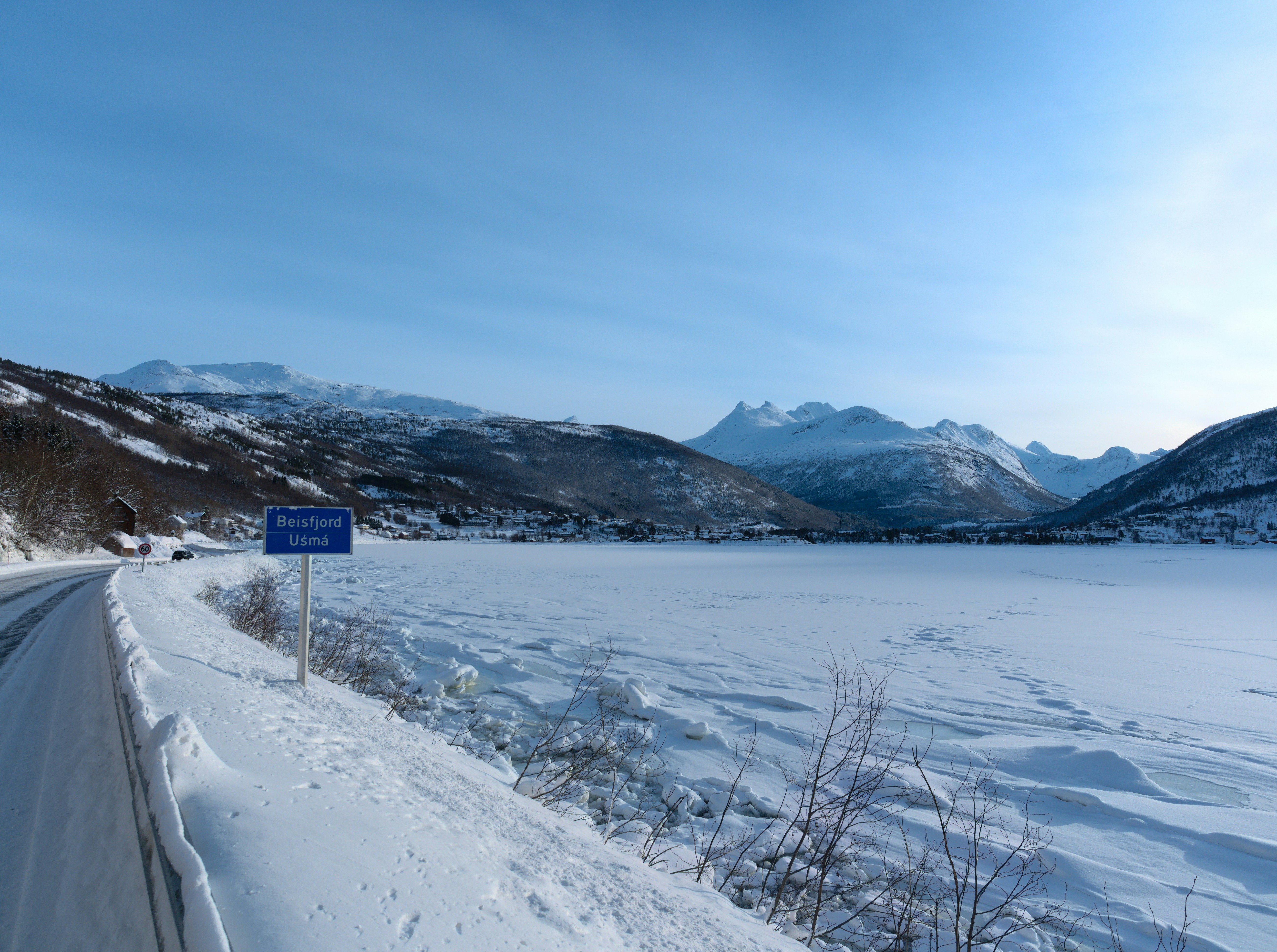 Snowbound Valley Road Toward Alpine Peaks
