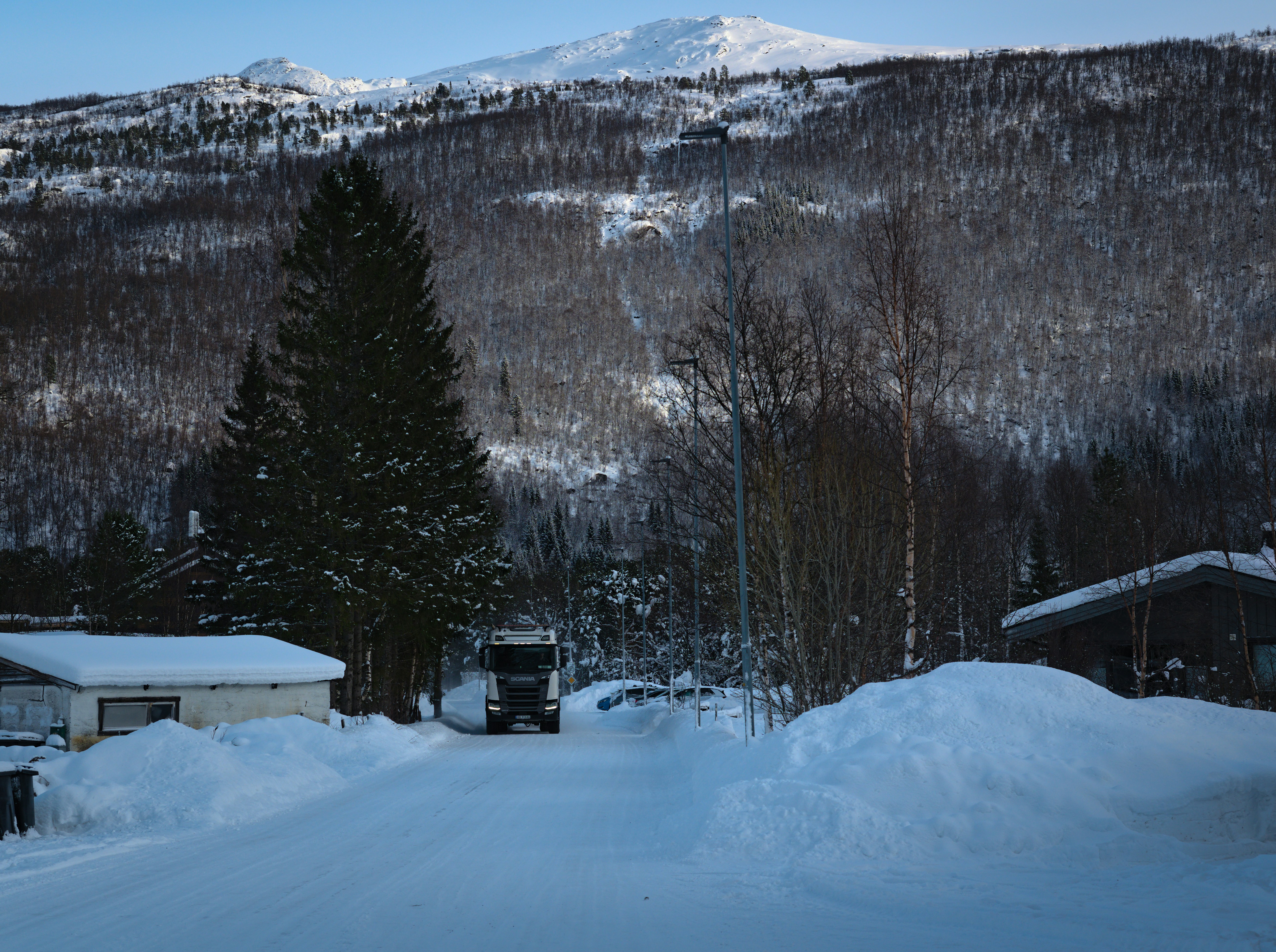 Snowbound Street Leading to a Snow-Covered Mountain Corridor