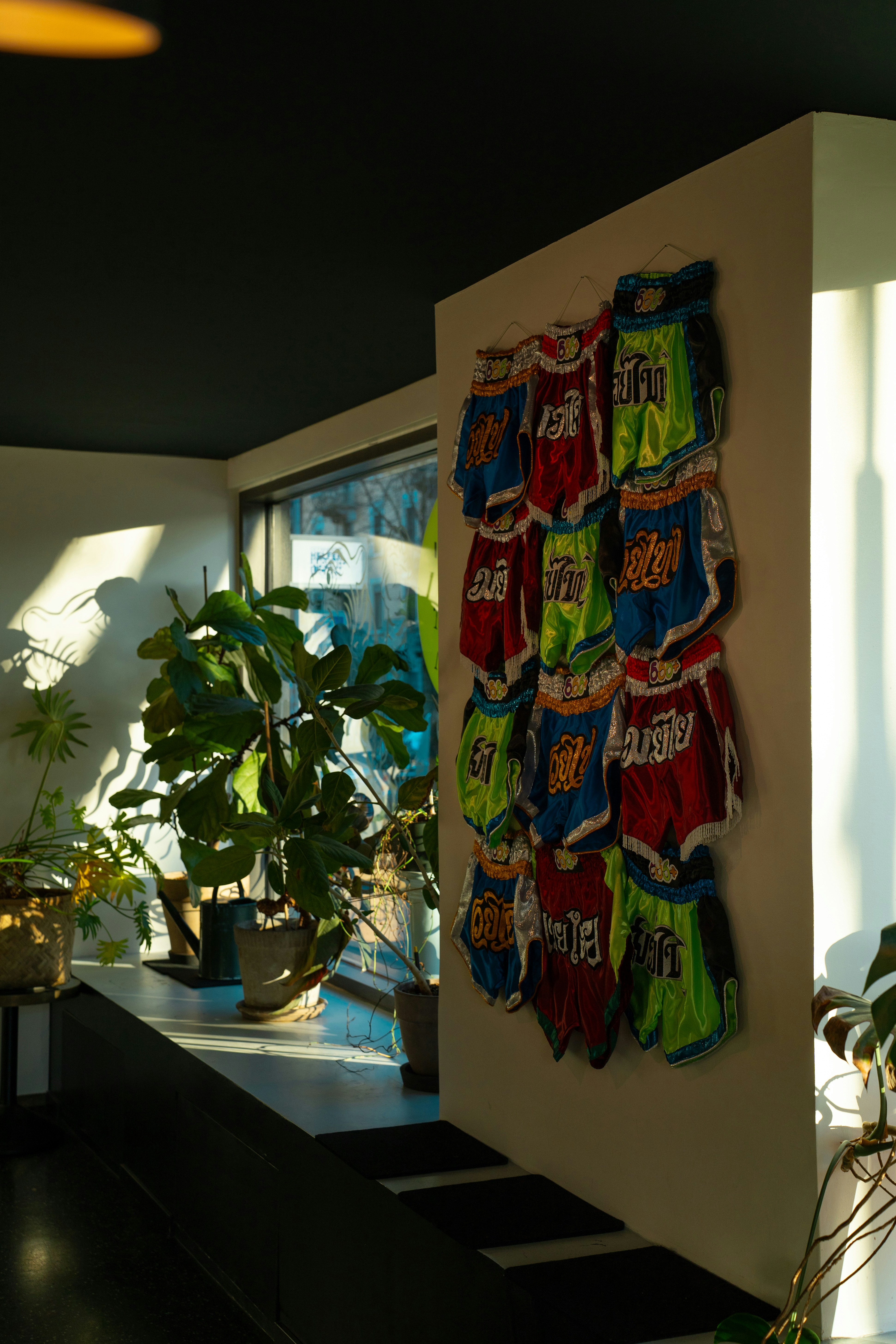 Colorful Muay Thai Shorts Wall in Quiet Office Lounge