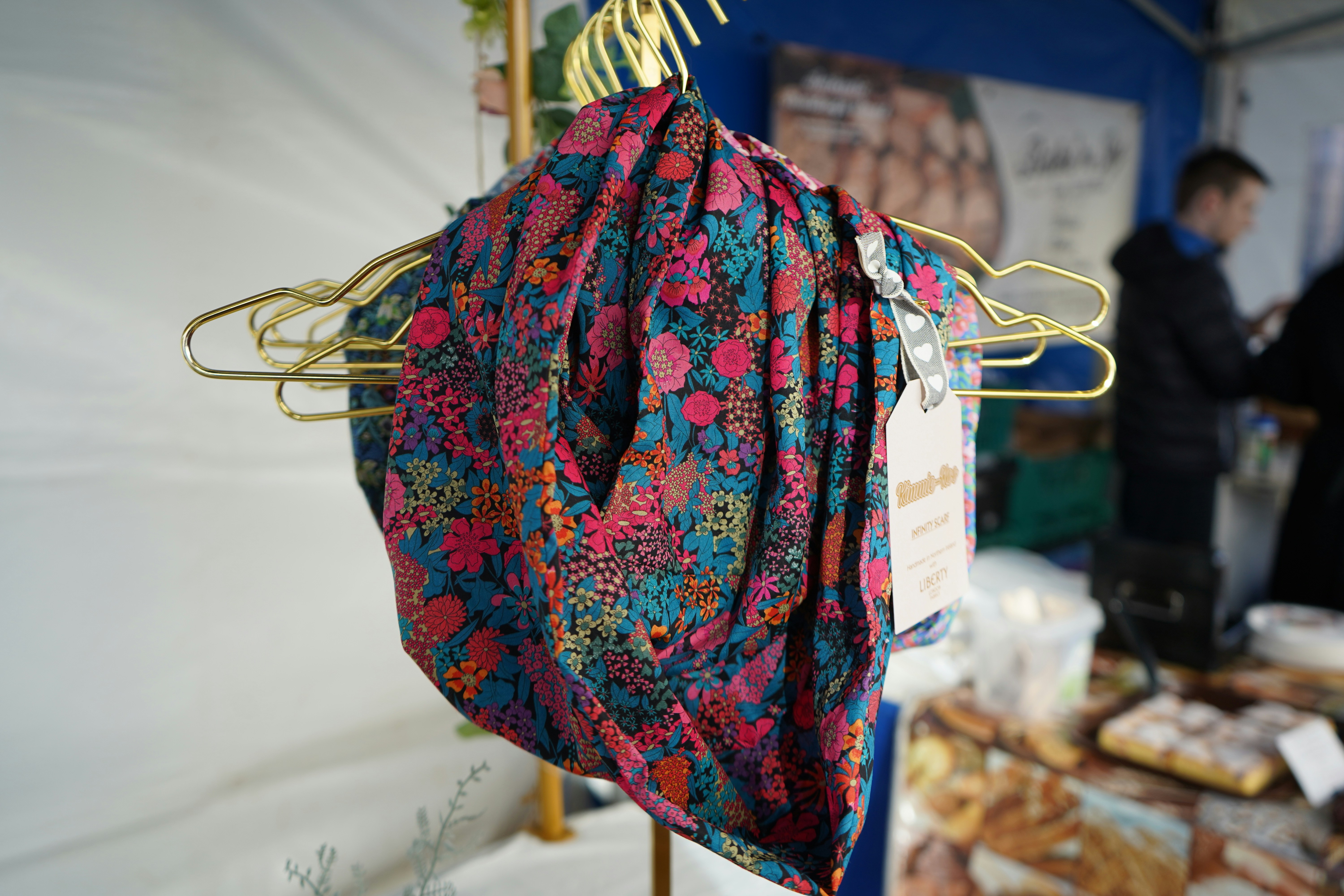 Colorful Floral Mask on Display at a Market Stall