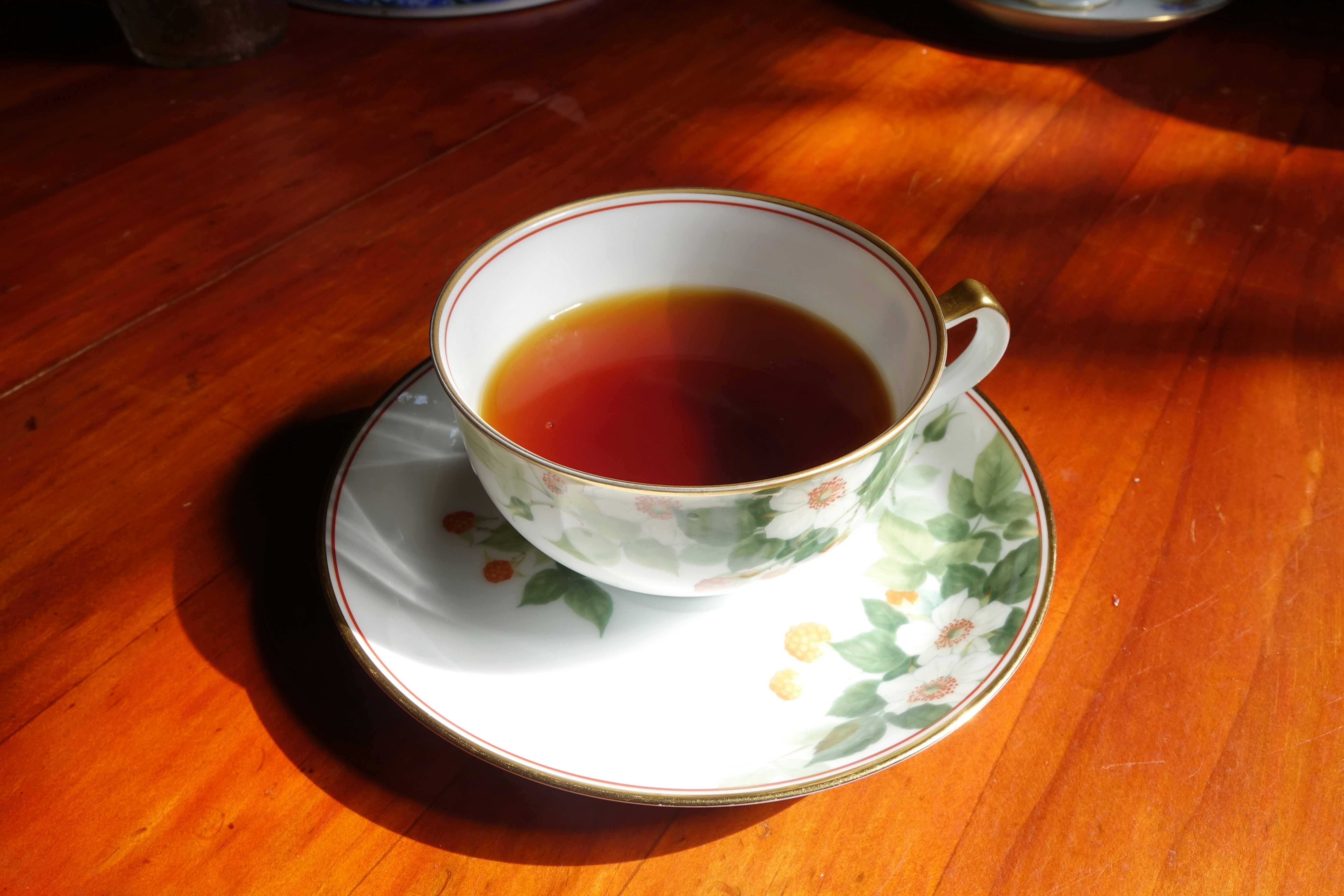 Tea on a Sunlit Table: A Delicate Porcelain Moment