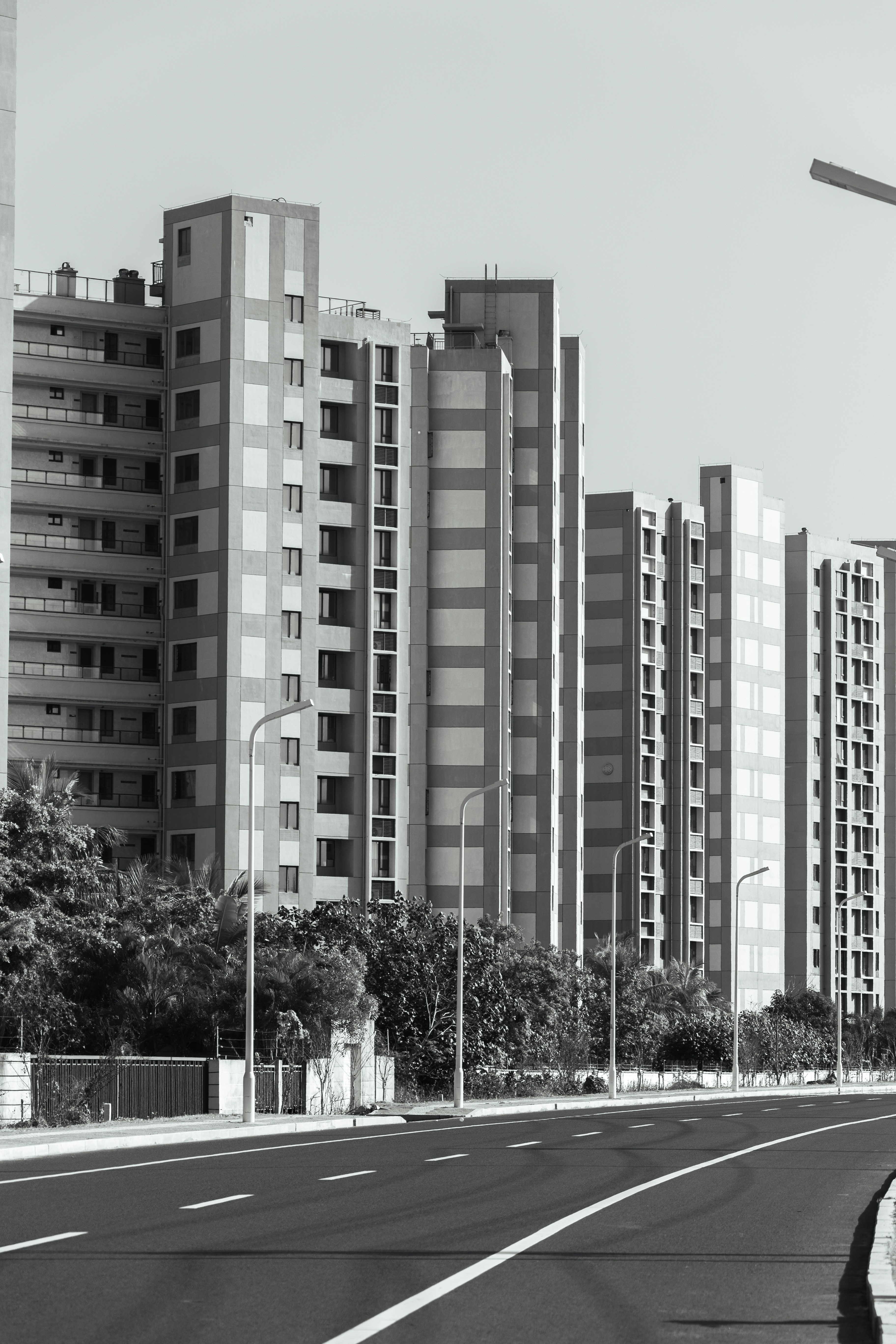 Rows of Towers Ascend: A Quiet Street Between Concrete Giants