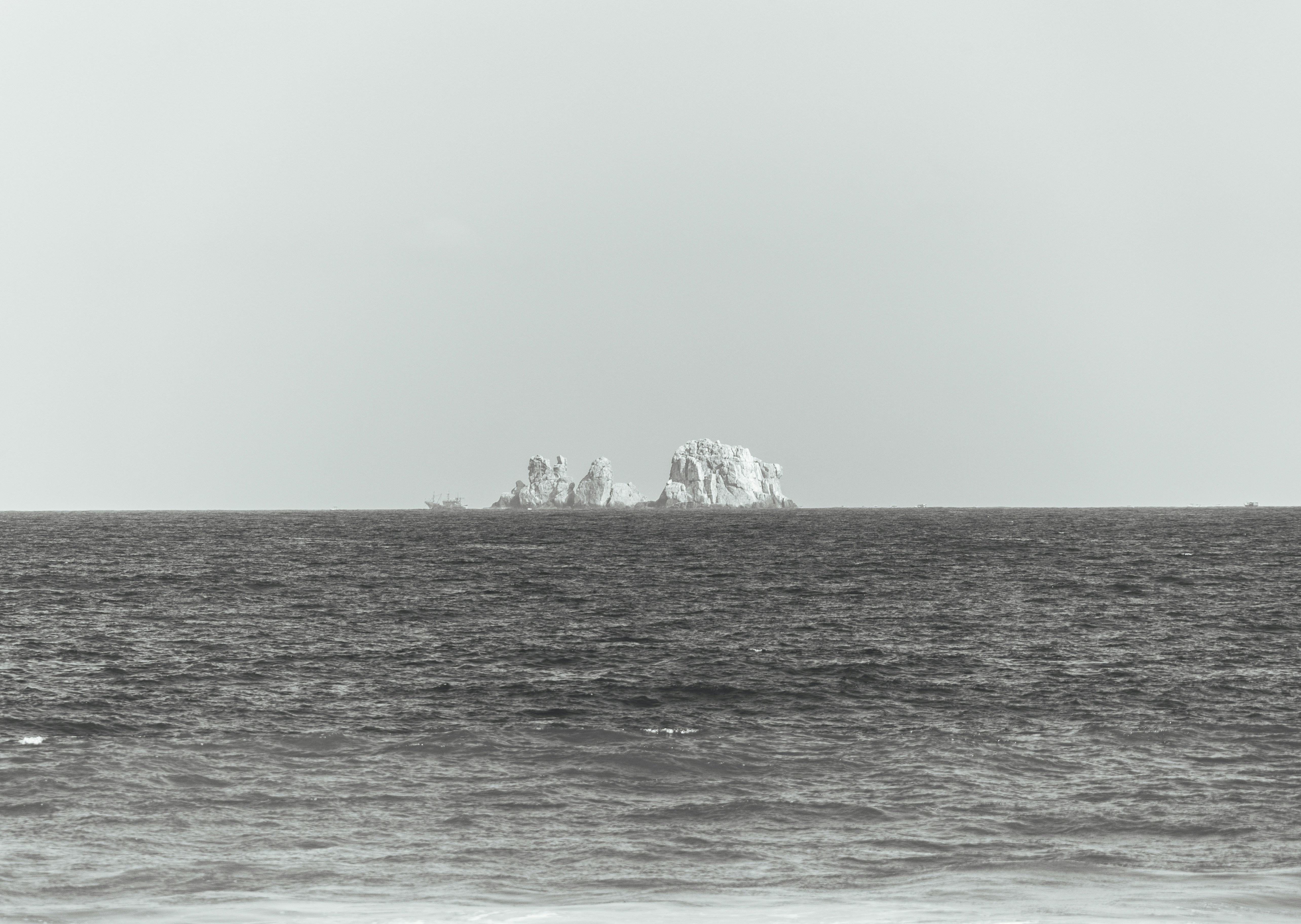 Isolated Rock Island on a Misty Horizon